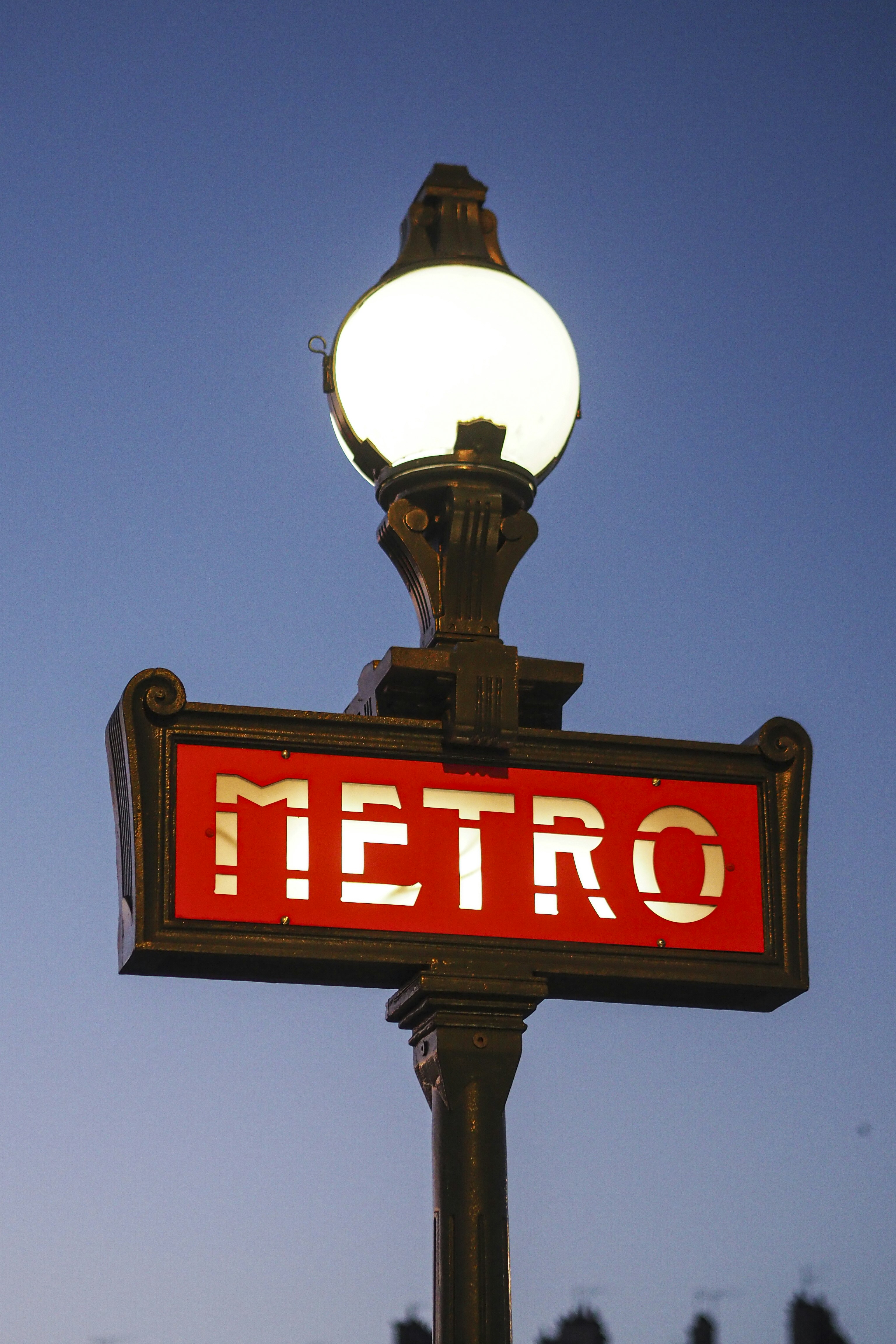 A classic french metro sign illuminates the night. photo – Free Paris ...