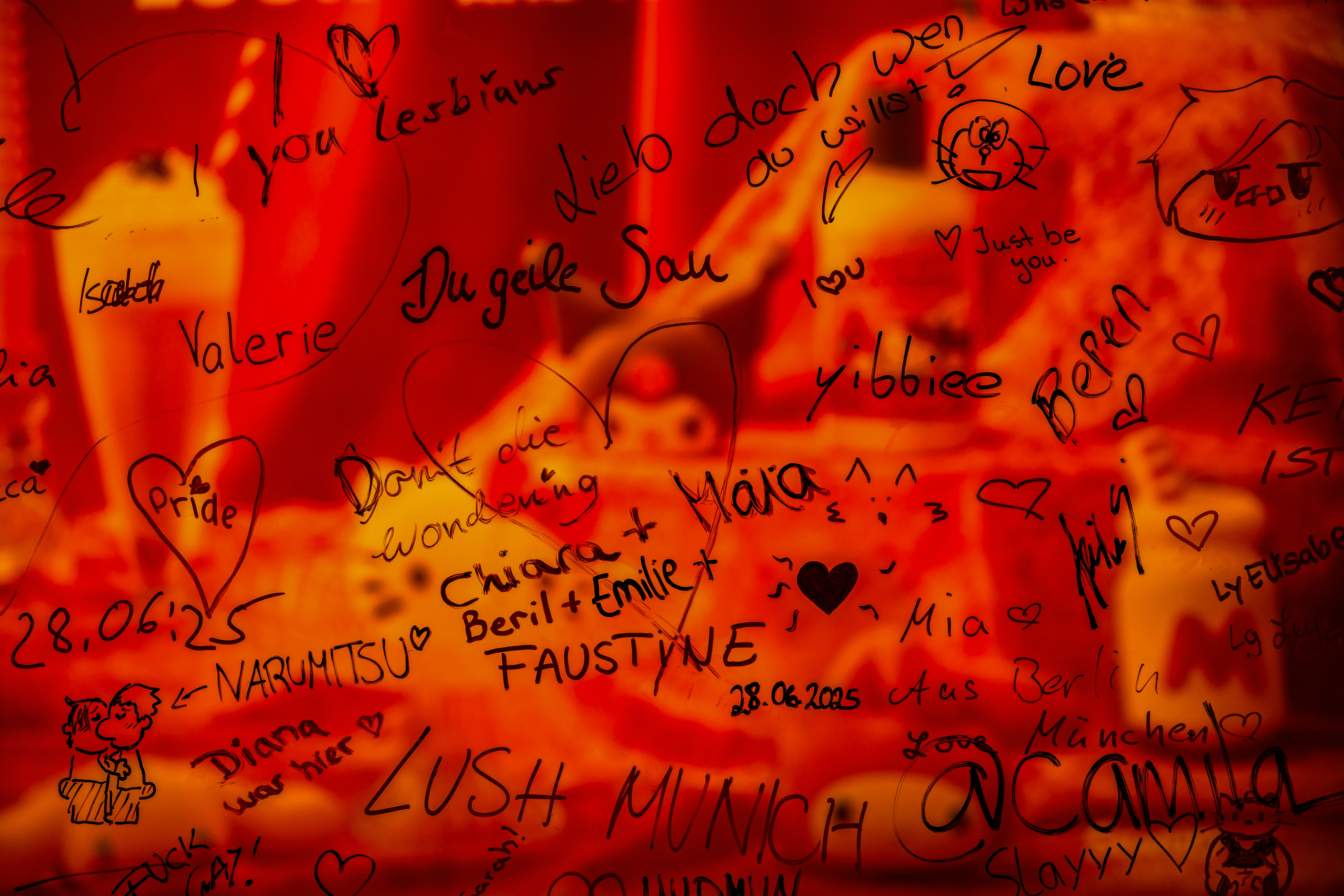Crimson Graffiti Through a Soft Glass Veil