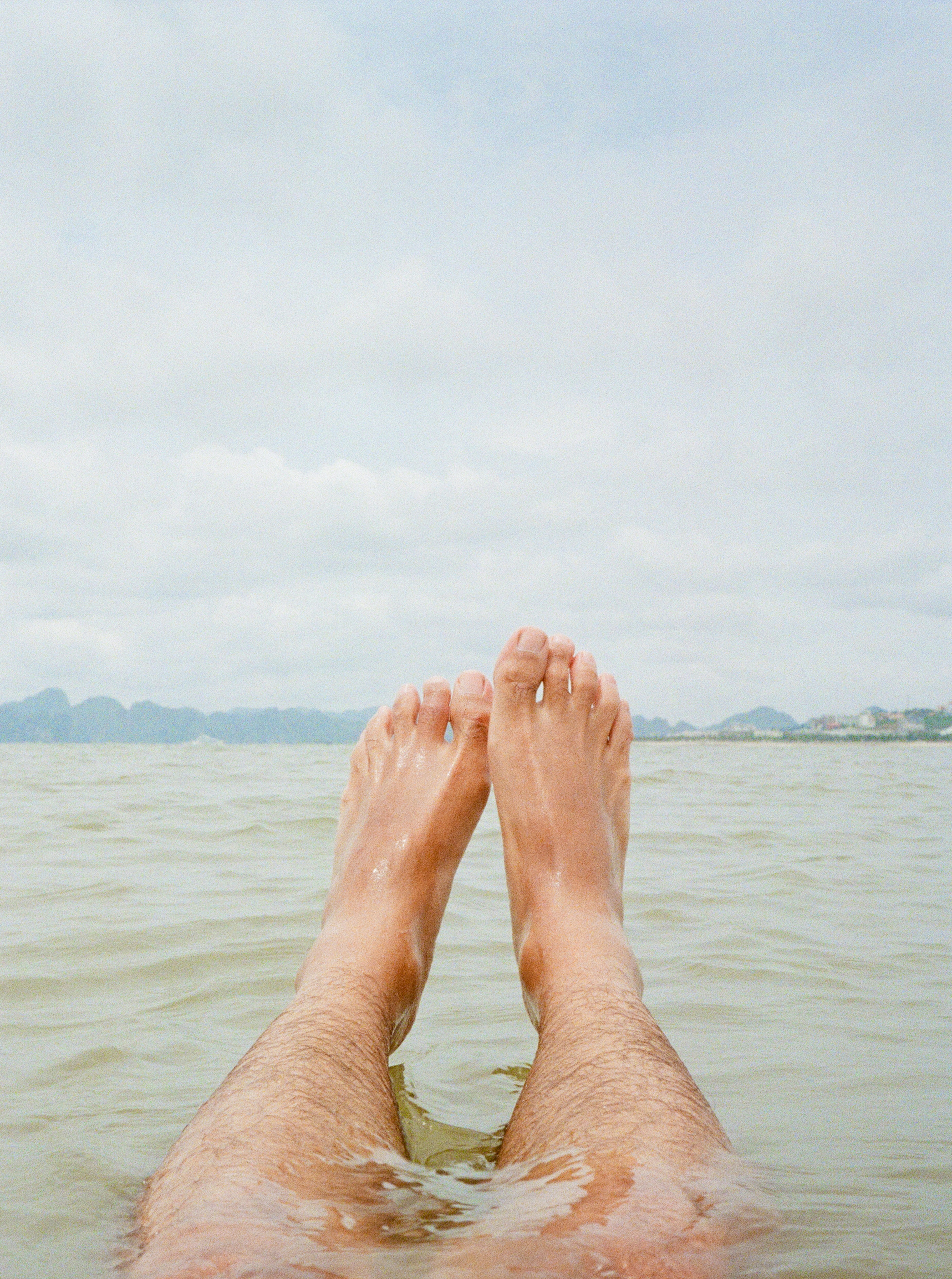 Feet relaxing in the water under the sky. photo – Free Portrait Image ...