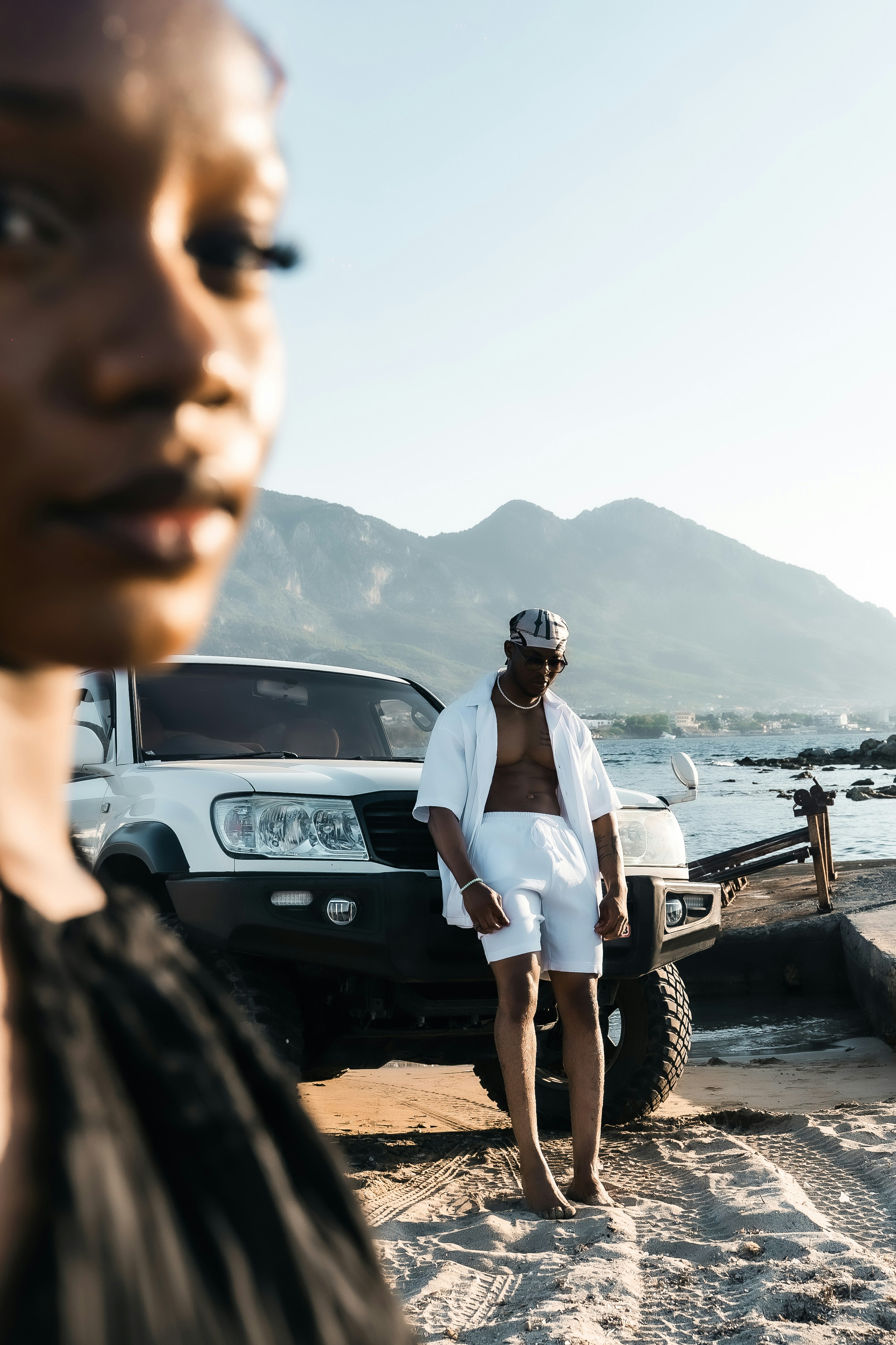 Near-Sunlit Coast: A Dual Portrait by the Jeep at Dusk
