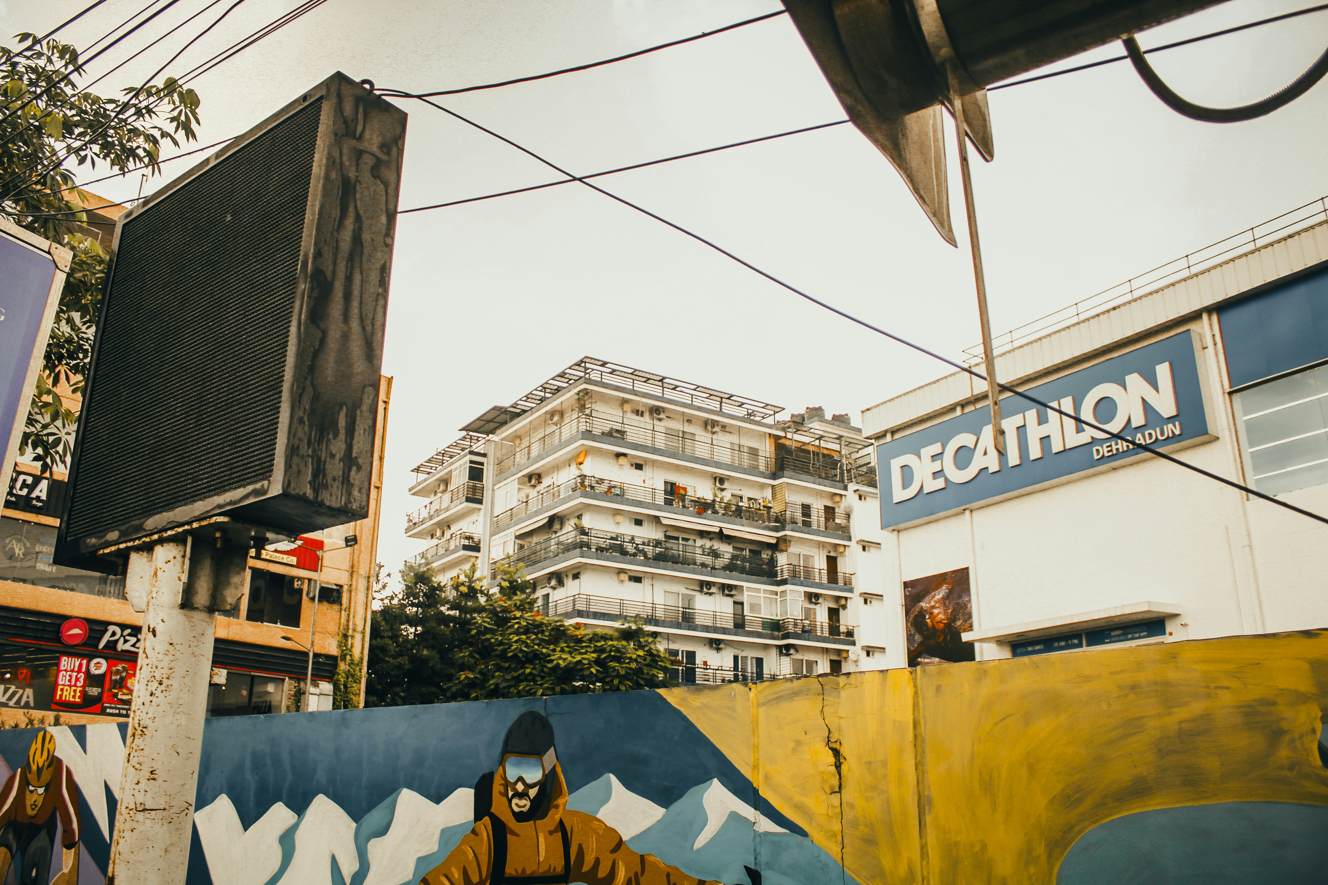 Cityscape features a building, sign, and a building.