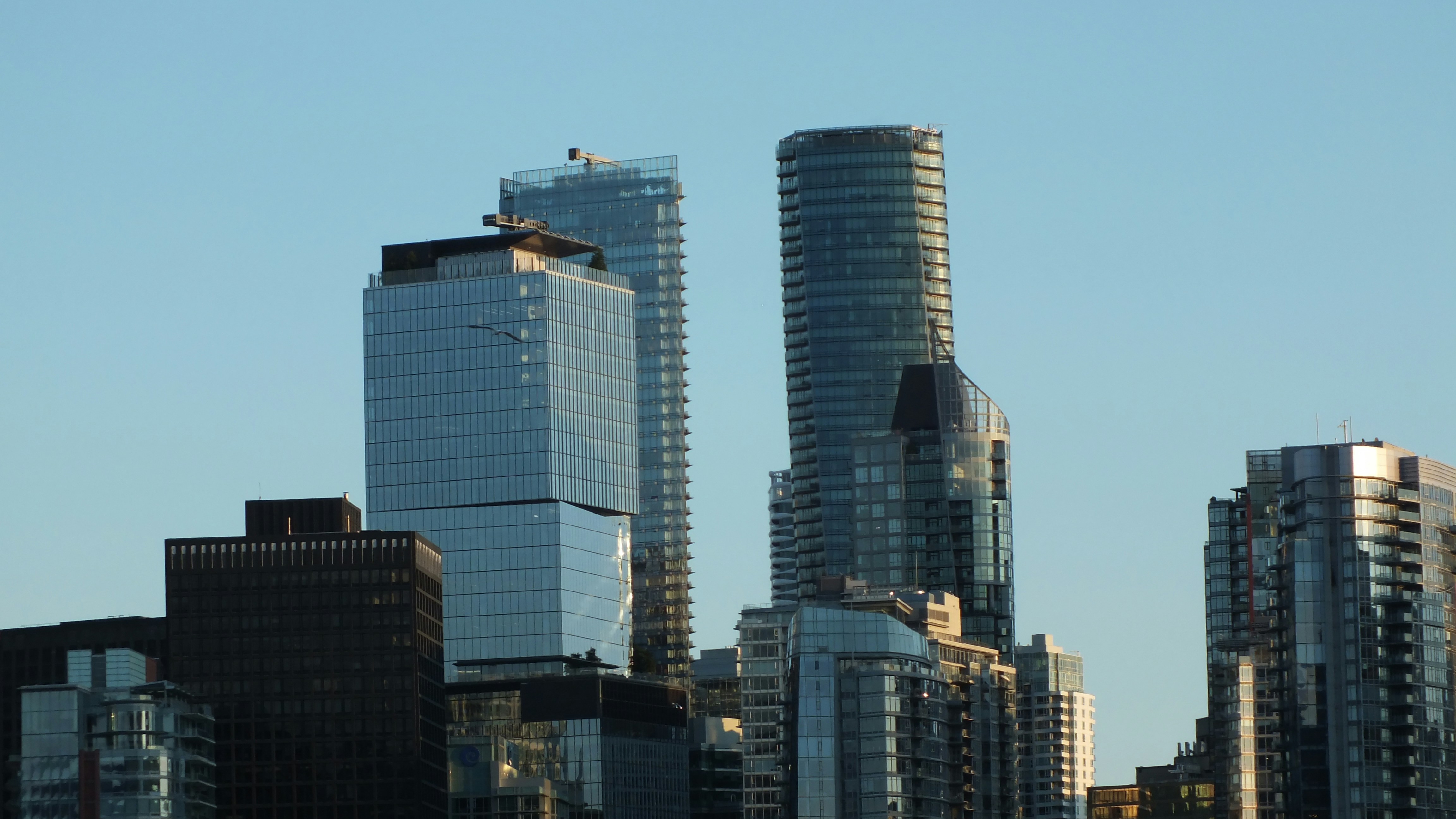 Skyscrapers reach towards the bright, blue sky.