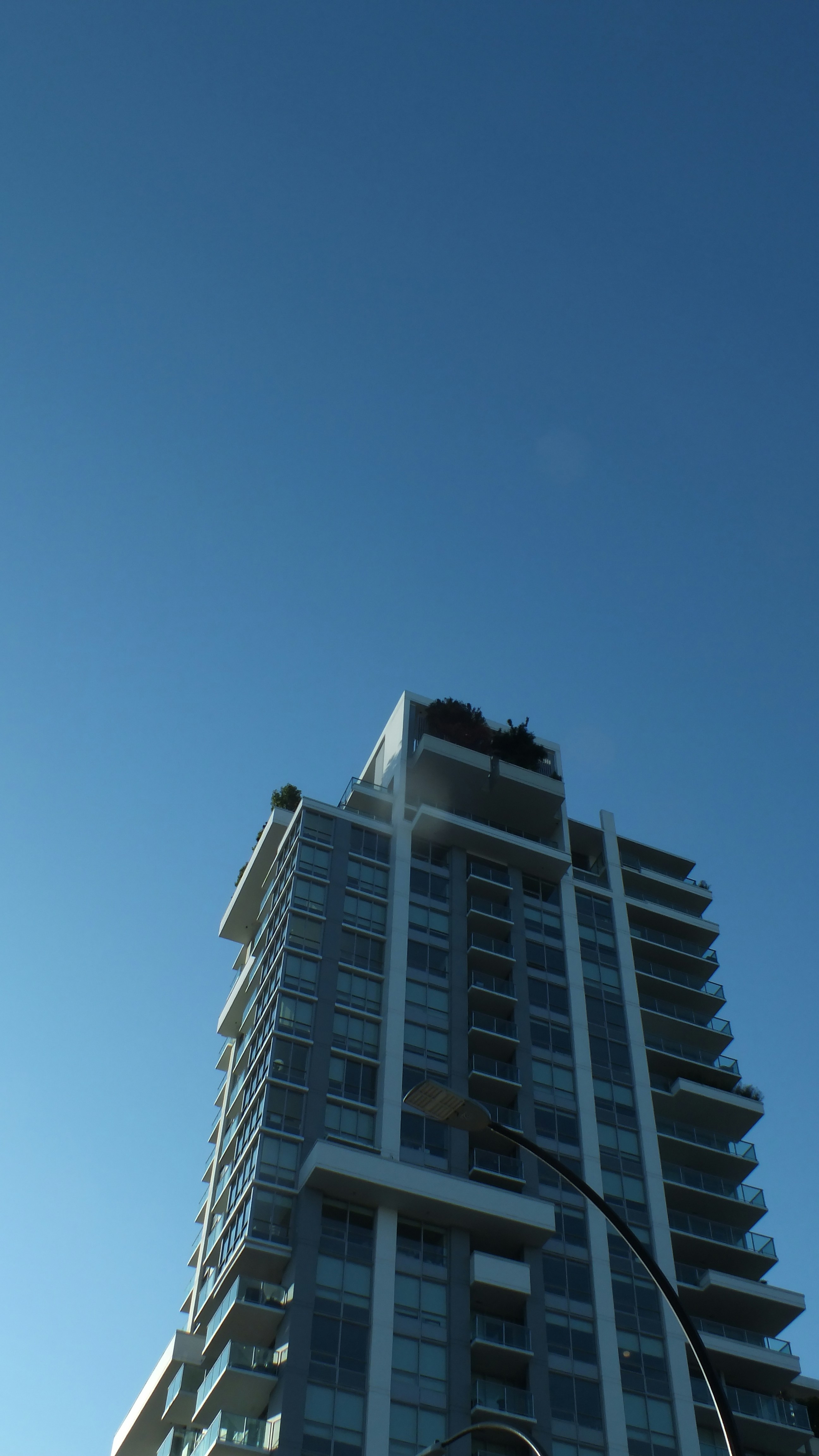 A modern high-rise building against a clear sky.