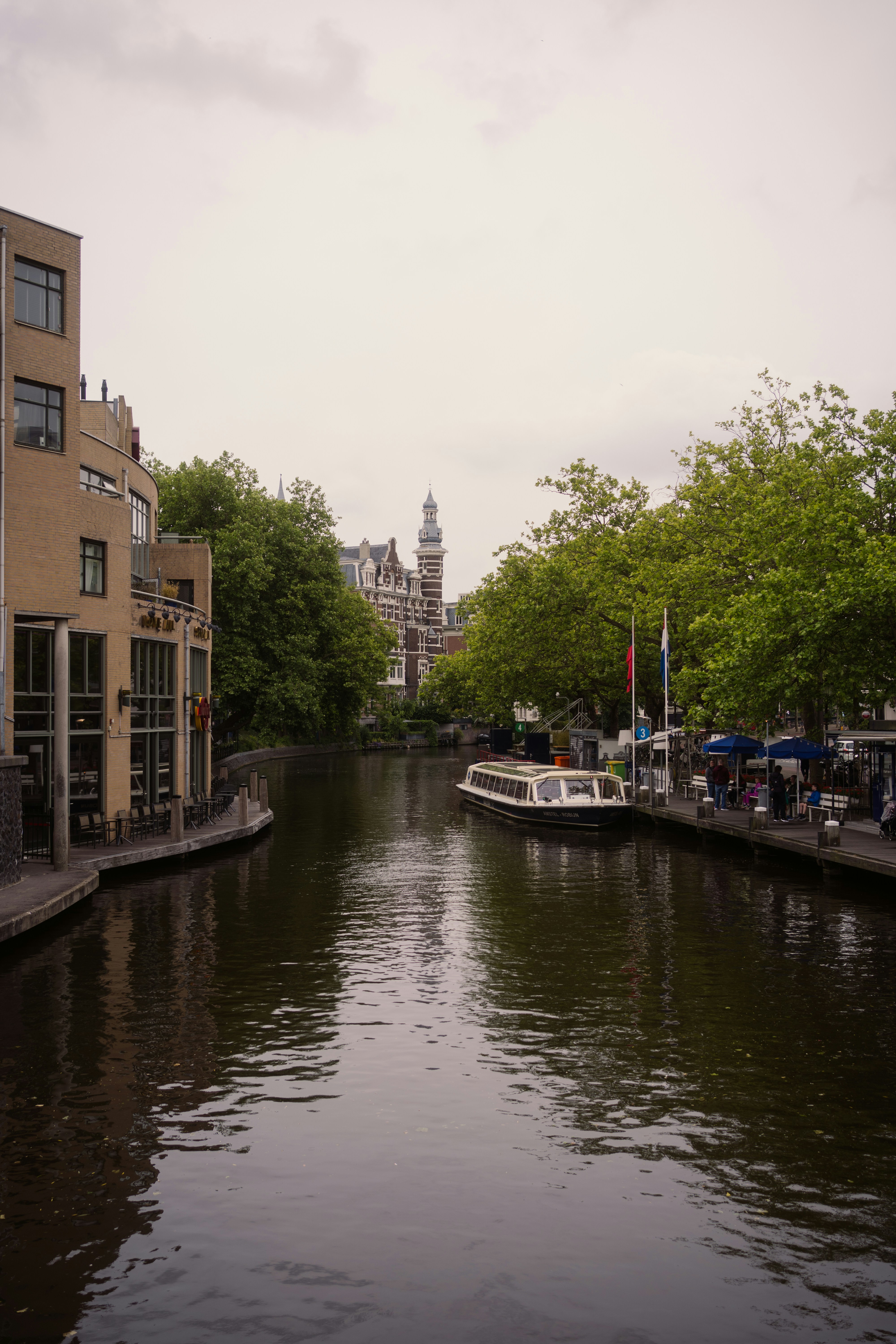 A boat cruises the canal in amsterdam.