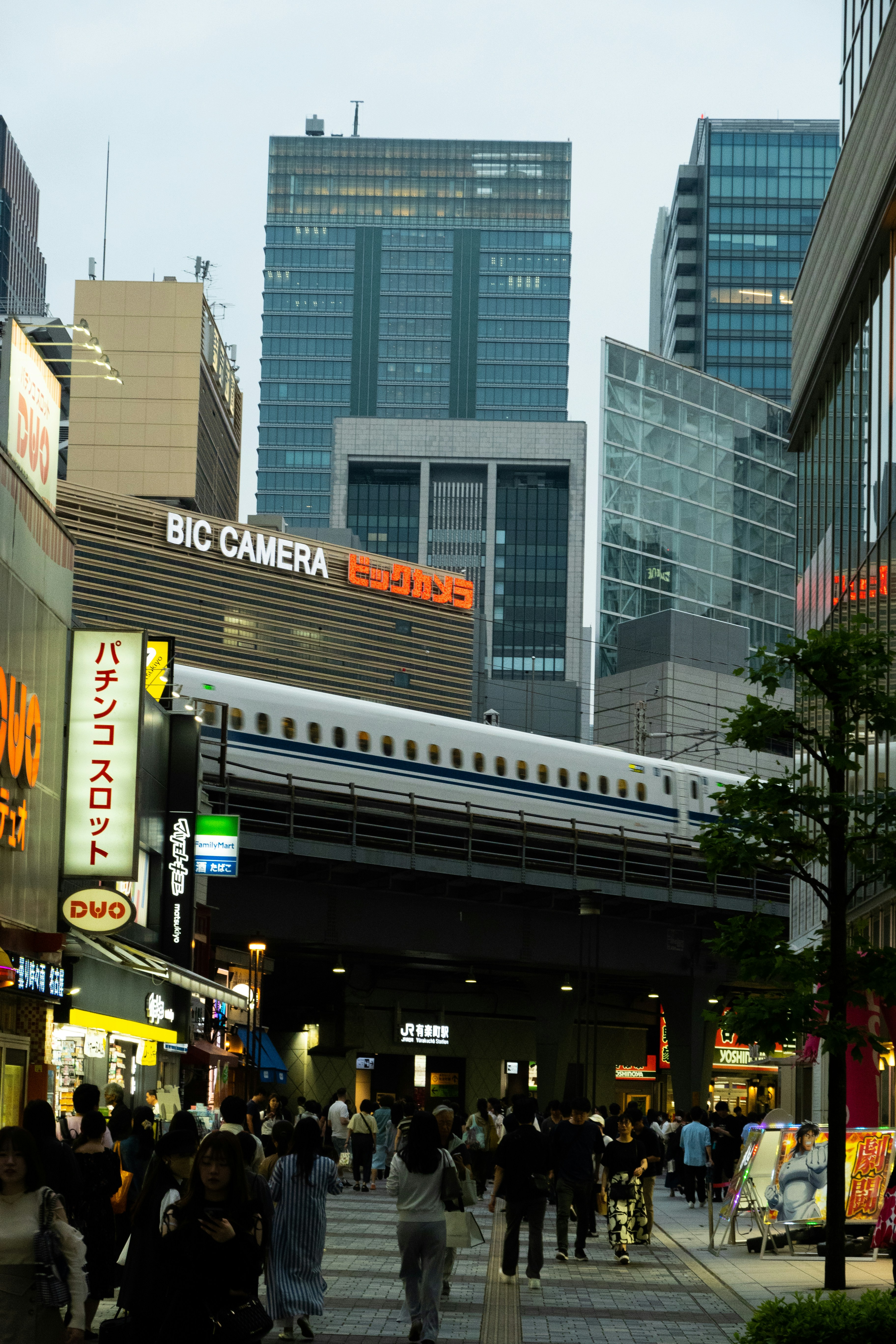 Monorail Glide Above a Bustling Tokyo Street Corridor