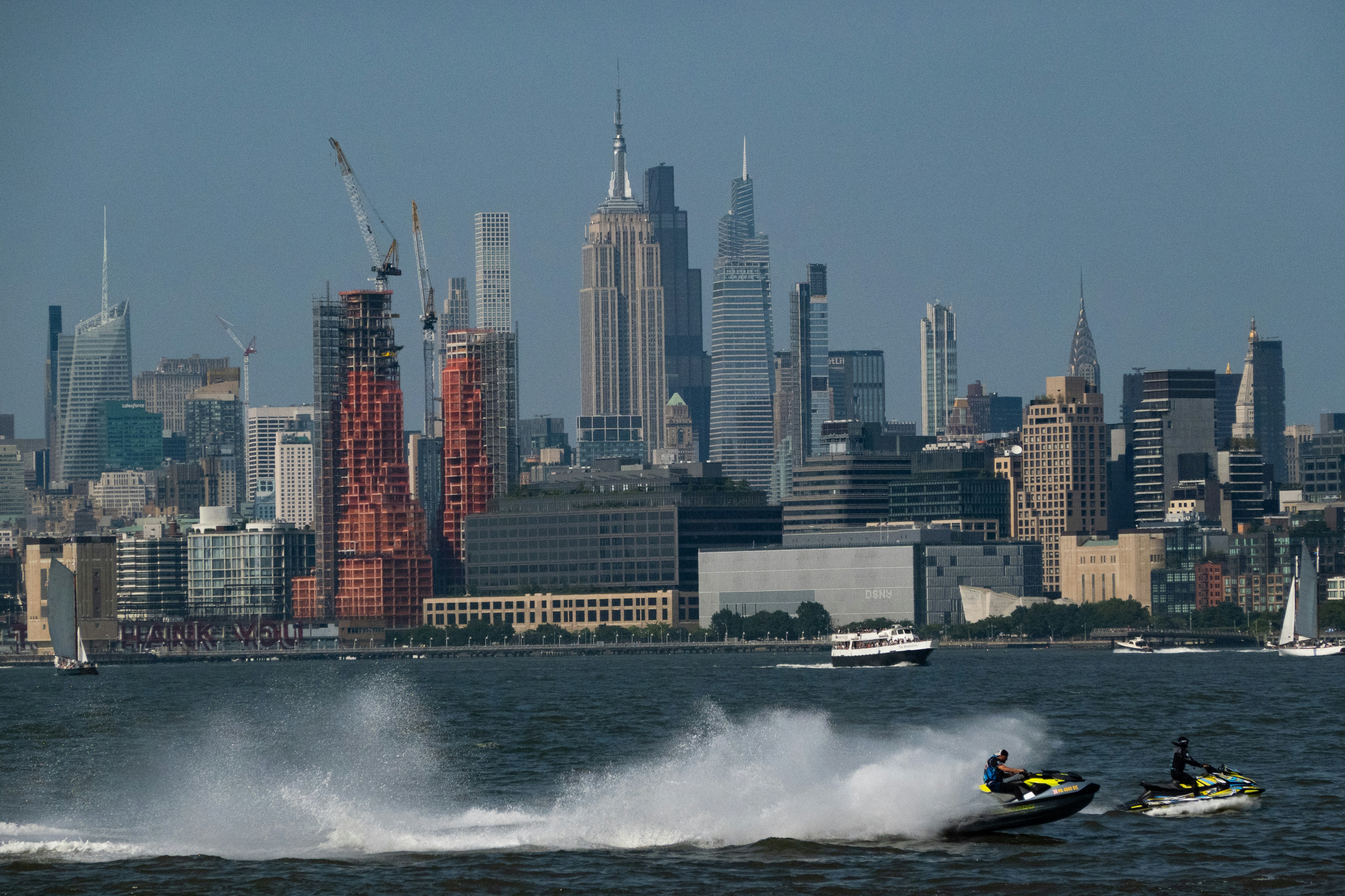 Cityscape on the Water: Jetski Wake Under a Concrete Sky