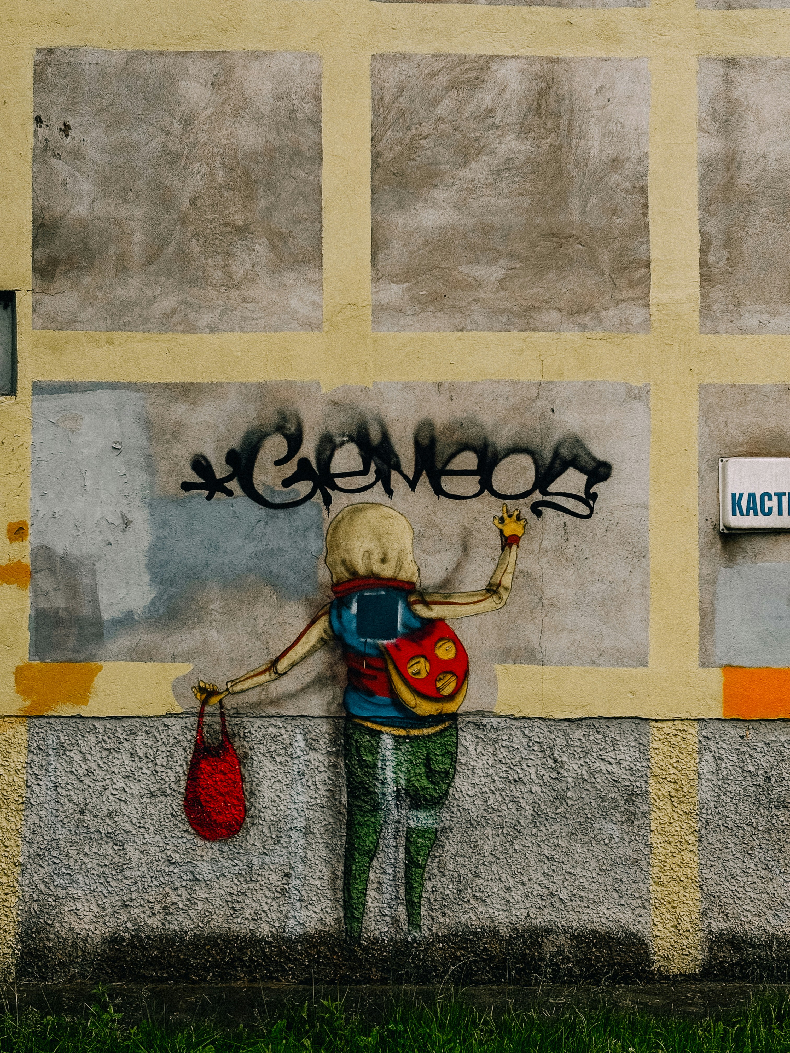 Child with a Red Balloon Backpack Painted on a Weathered Wall