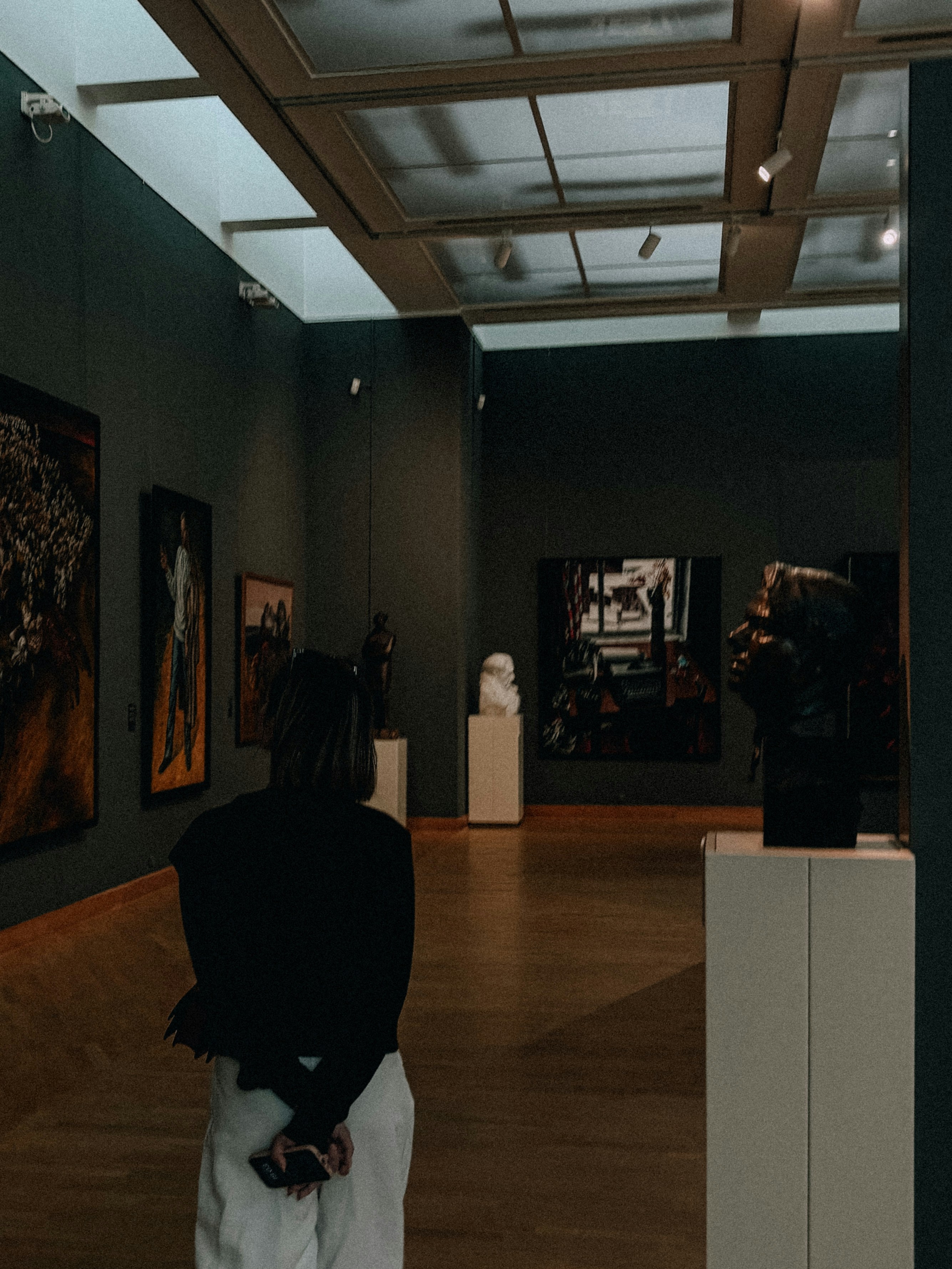 Person looks at art in a museum.