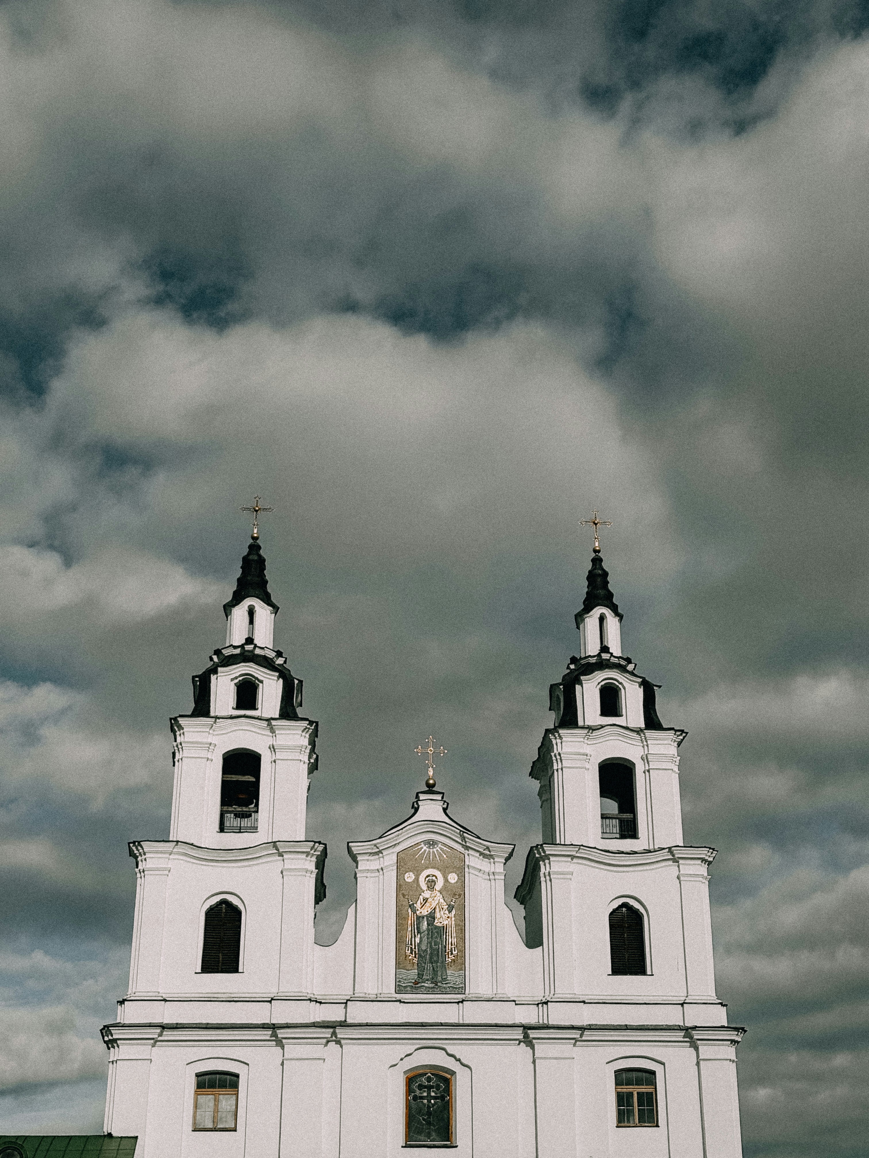 White church with dramatic clouds in the sky.