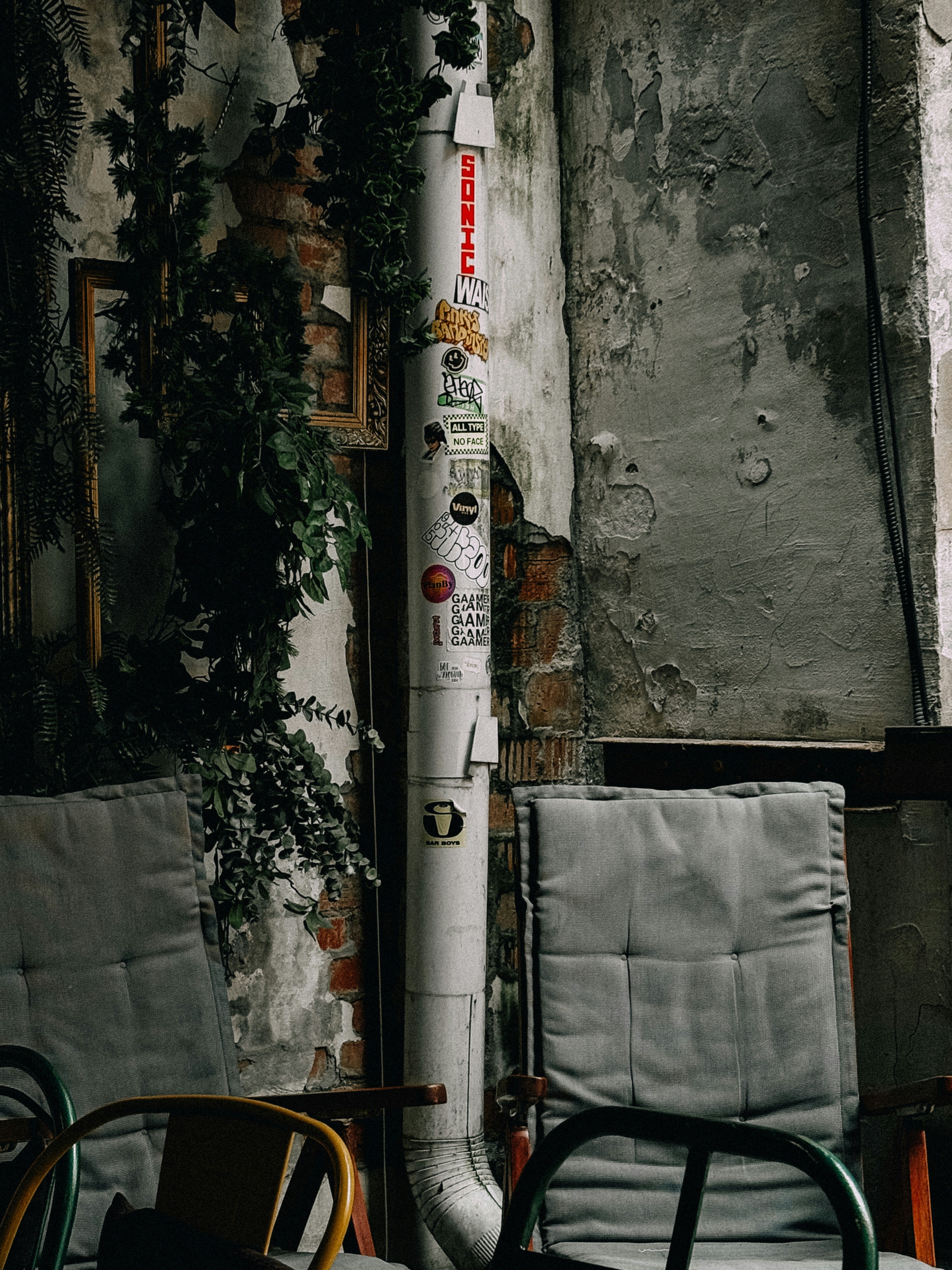 Rustic, aged interior with chairs and a pipe. photo – Free Wall Image ...