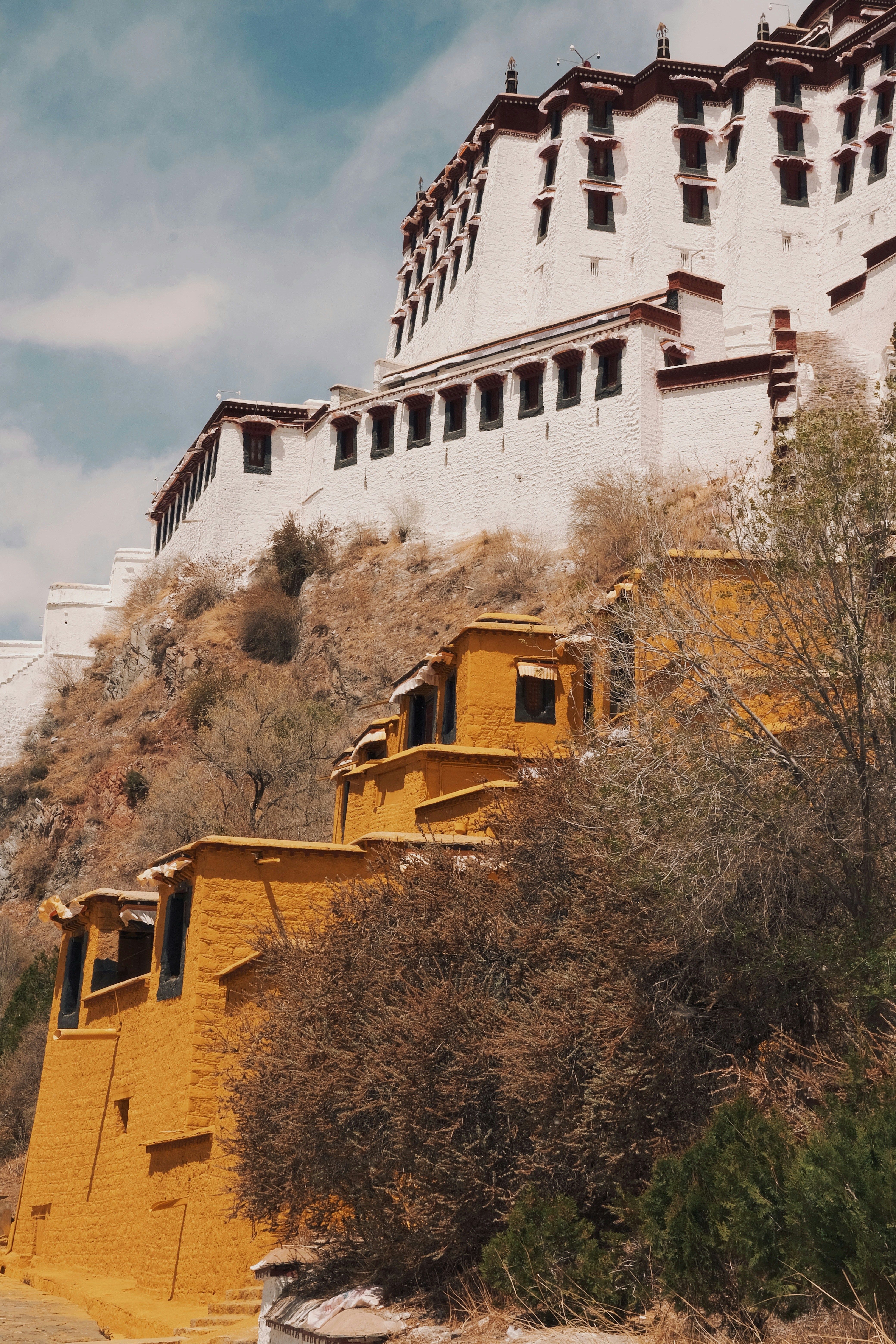 White Citadel Cresting a Golden Slope: Terraced Fortresses Under a Pale Sky