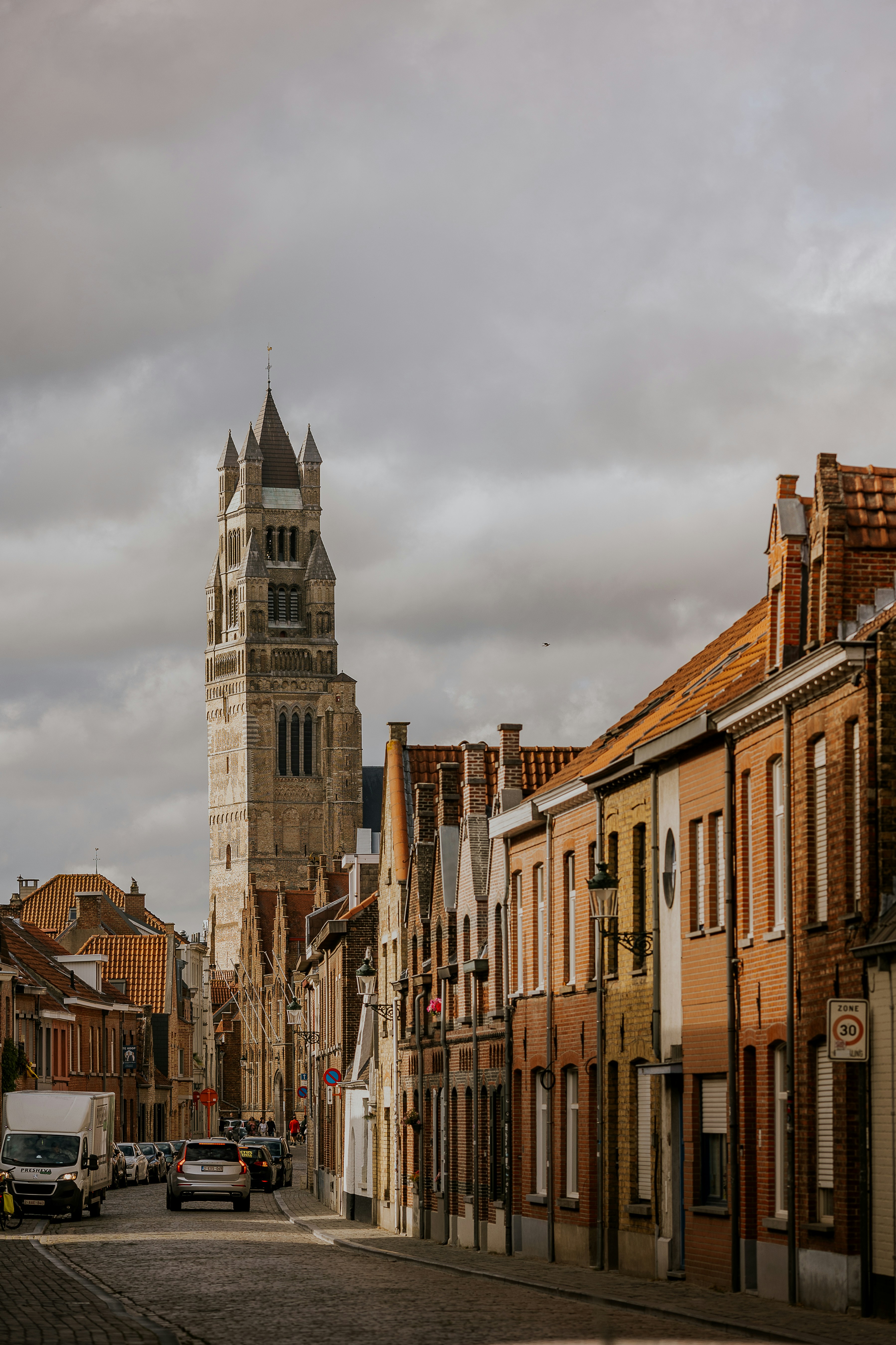 Bruges streets | A european town street with a tall tower.
