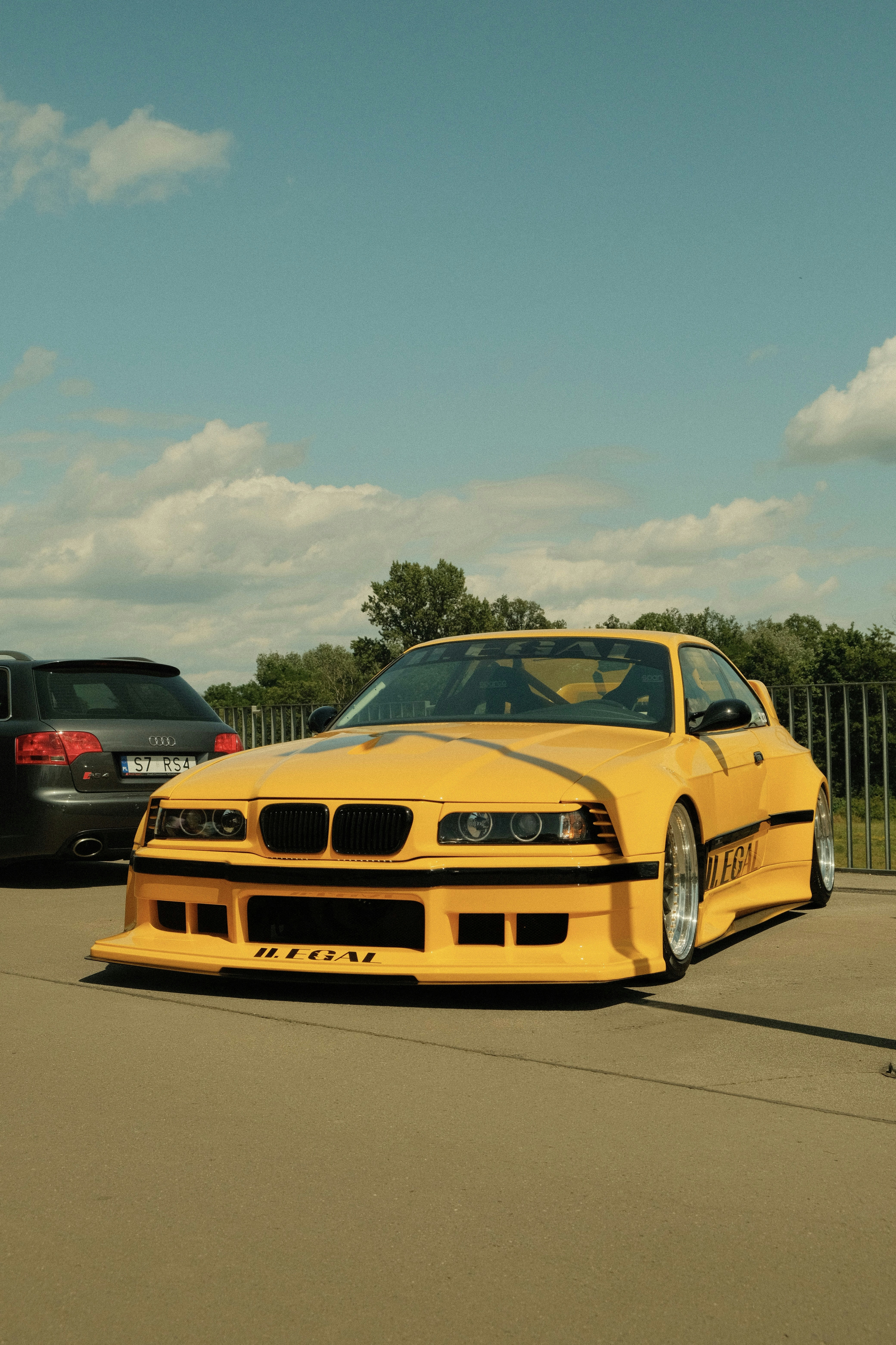 A bright yellow sports car on a clear day.