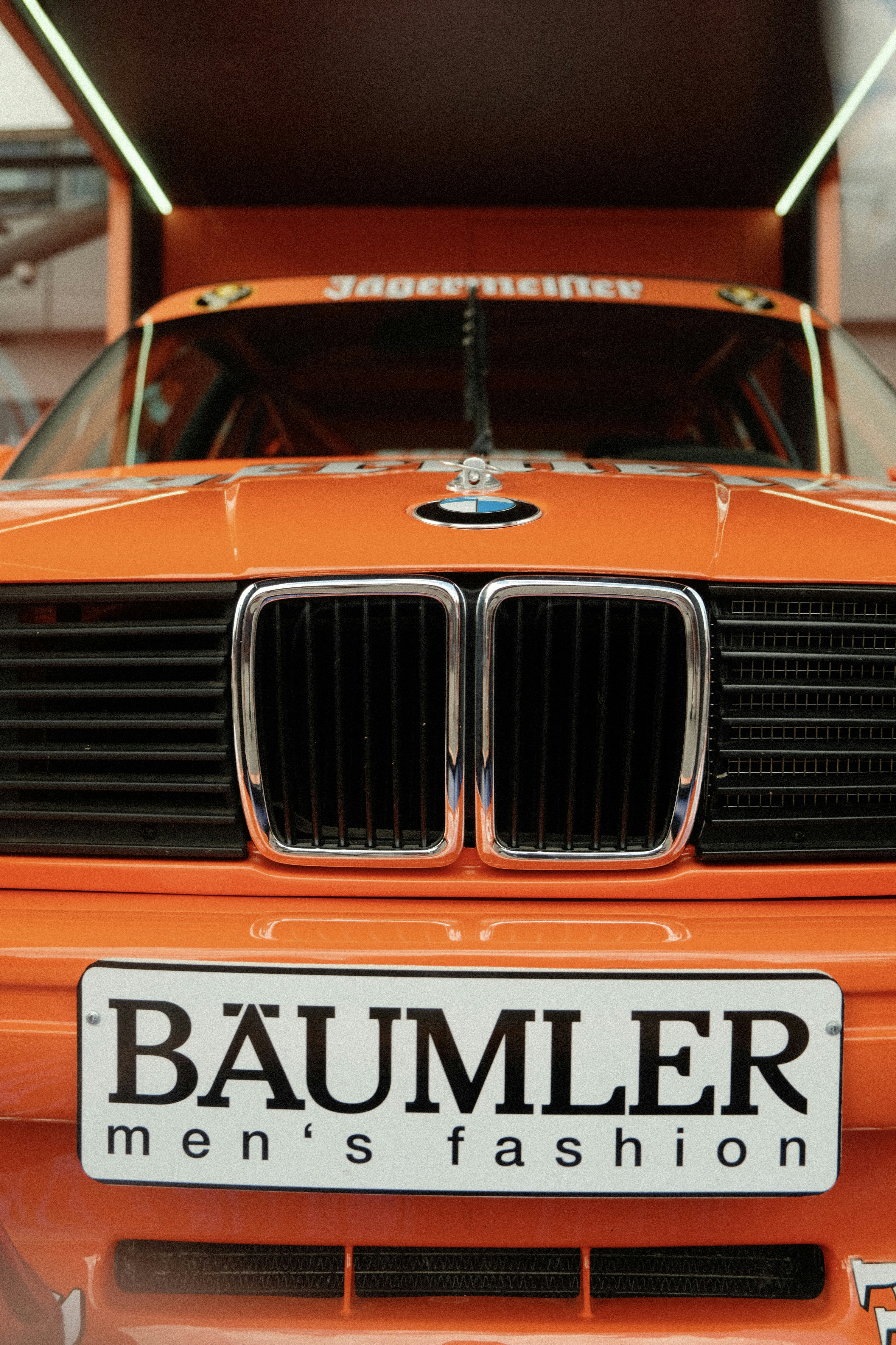 Neon-Glow Orange BMW Front: A Close-Up on the Kidney Grilles Under Garage Lights