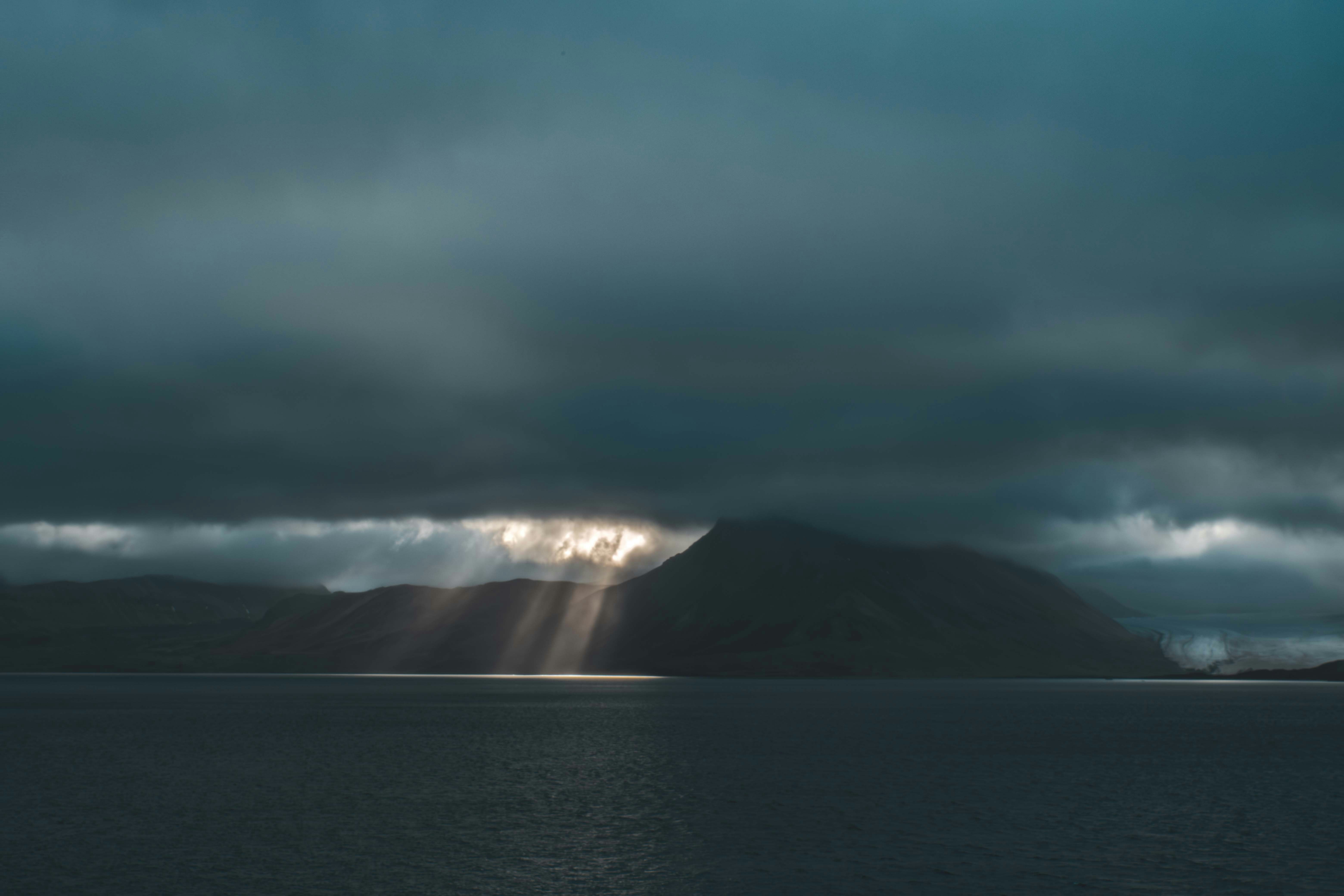 Rays of sunlight break through stormy clouds.