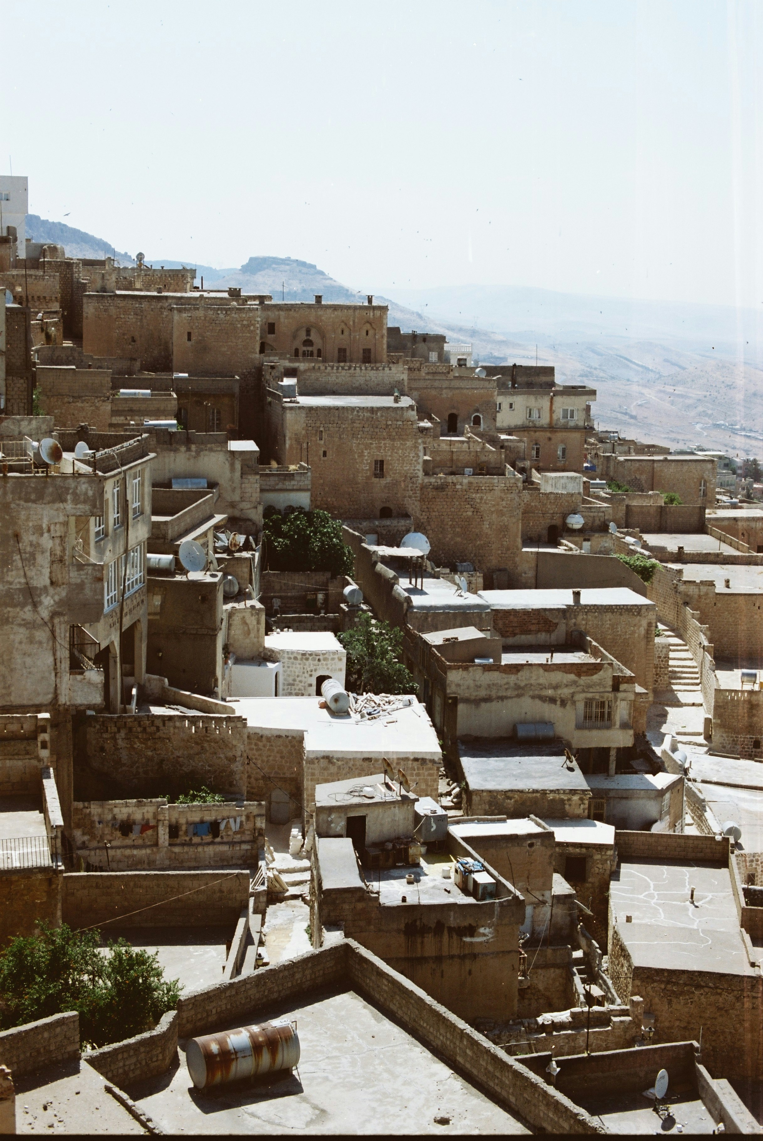 Stone houses cascade down a hillside.