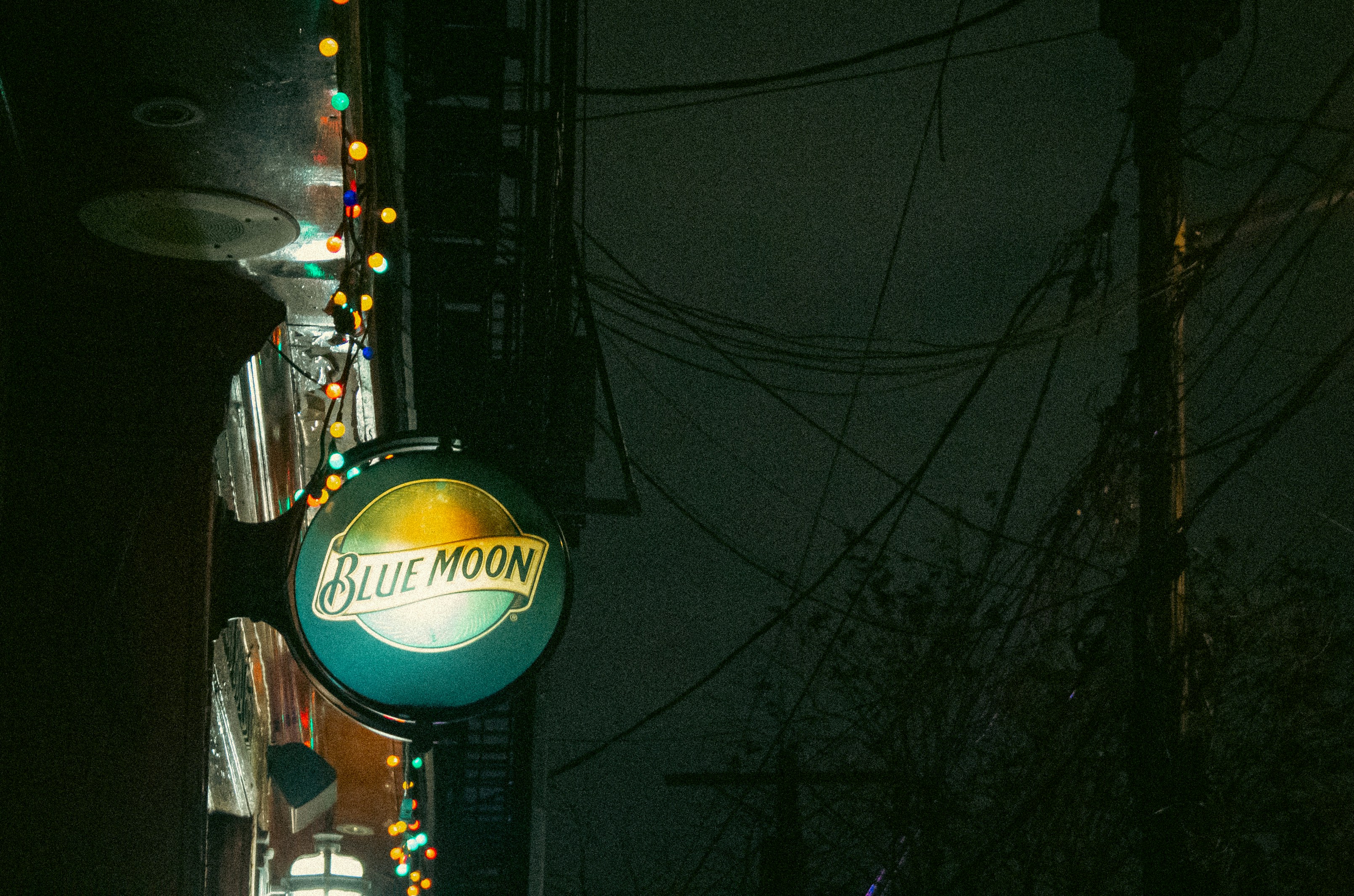 A blue moon bar sign glows in the night. photo – Free Night Image on ...