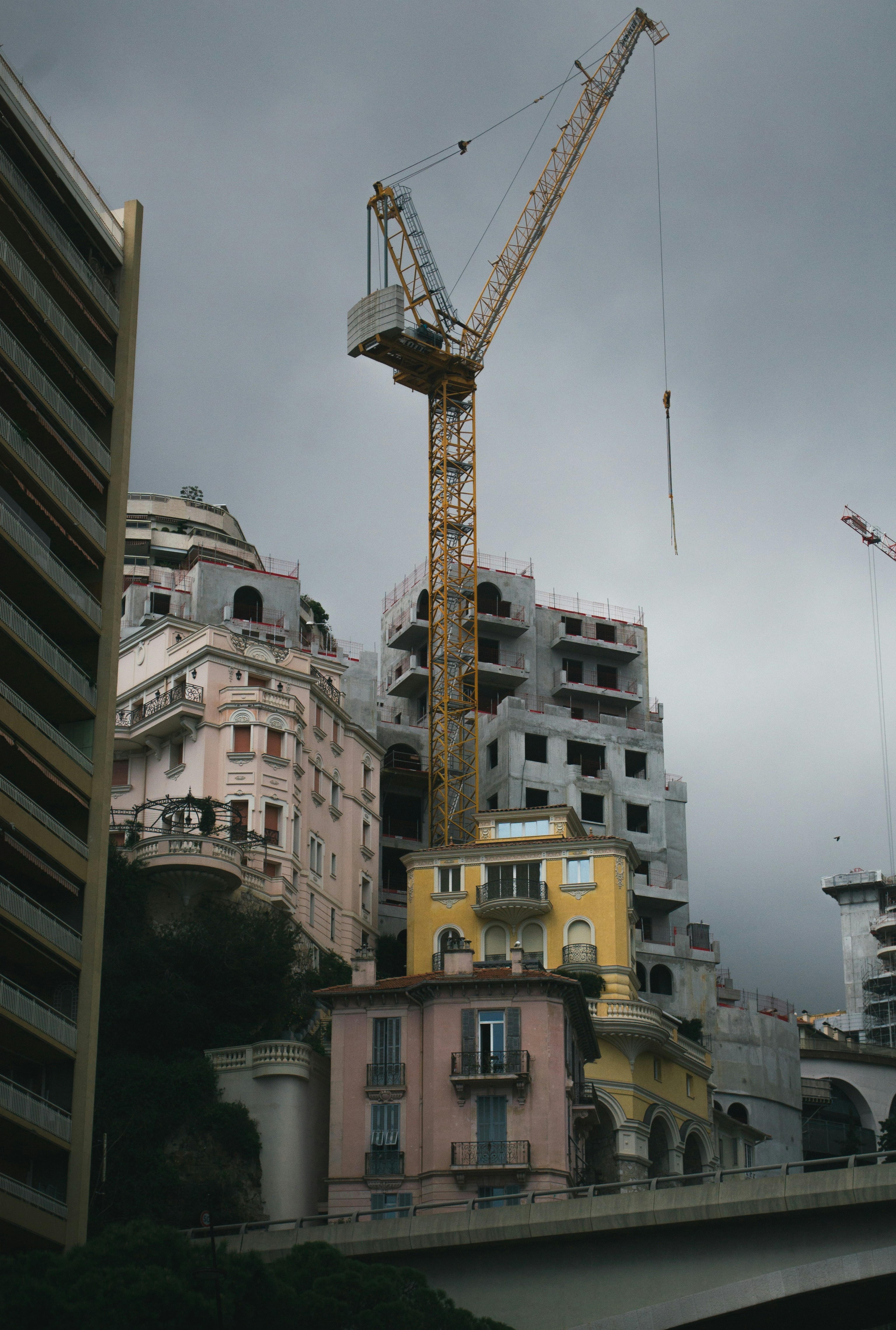 Construction cranes tower over old buildings.