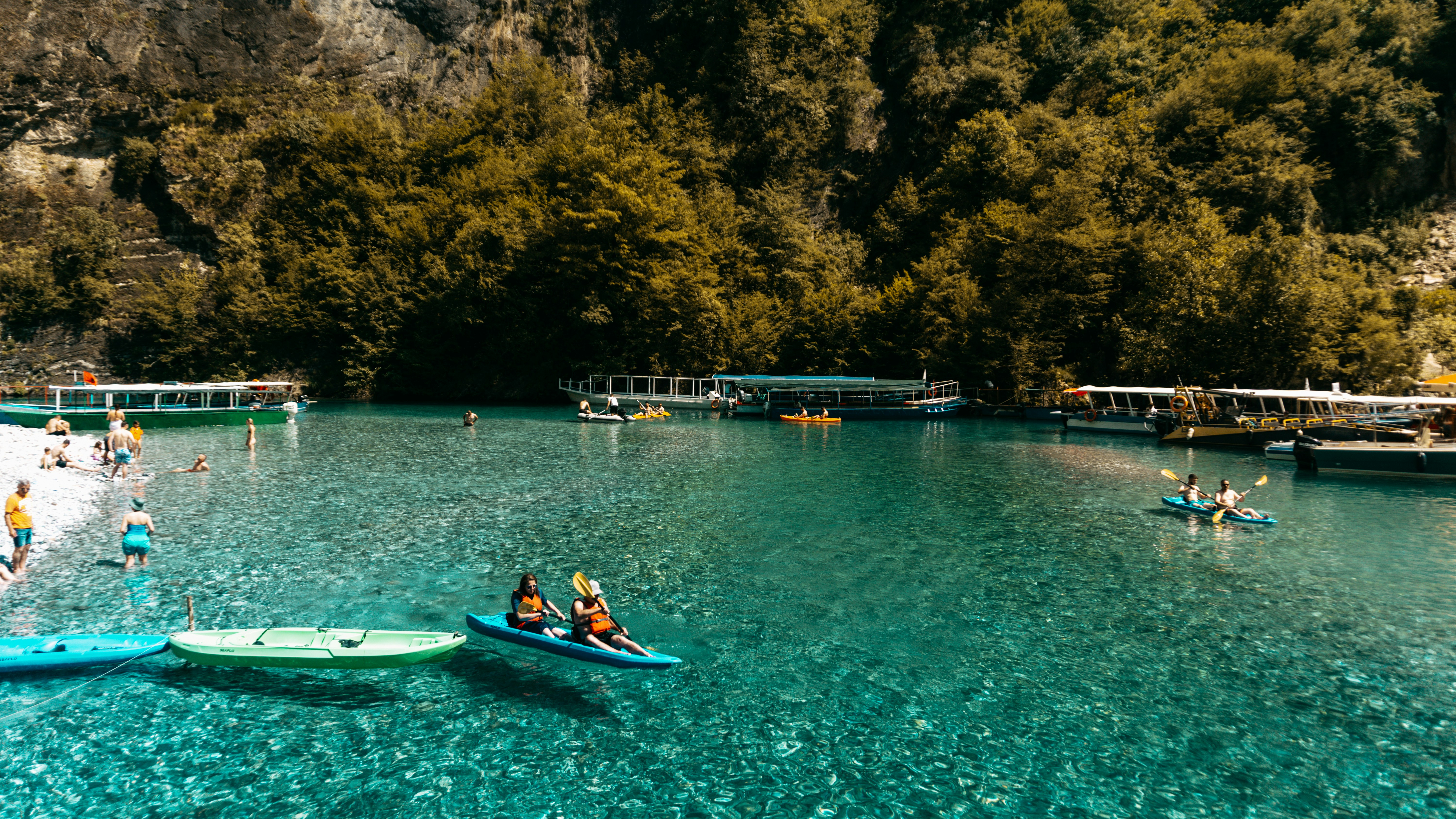 People kayak in a beautiful, clear turquoise lake. photo – Free Green ...
