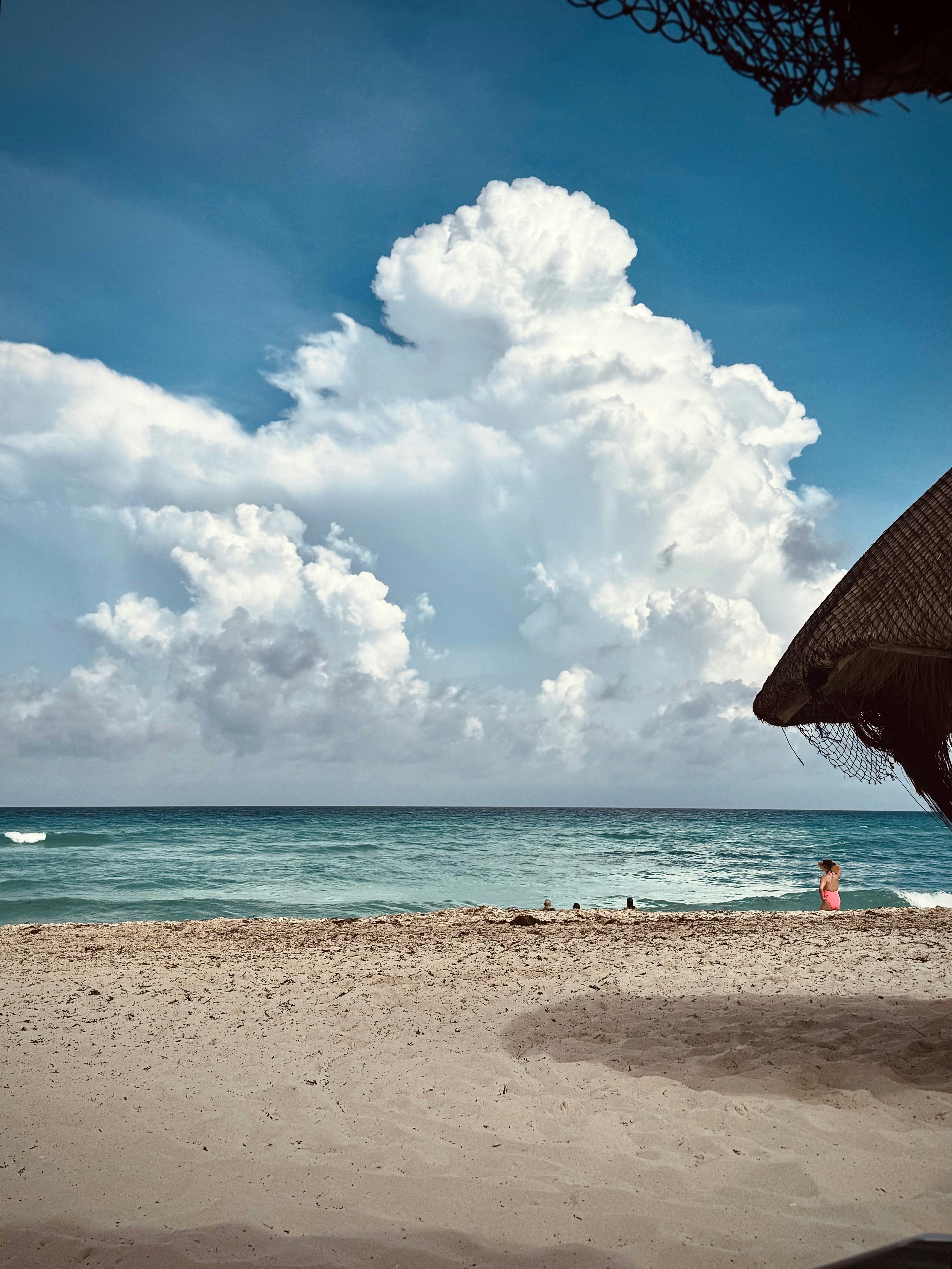 A beach scene with dramatic clouds and blue skies. photo – Free Human ...