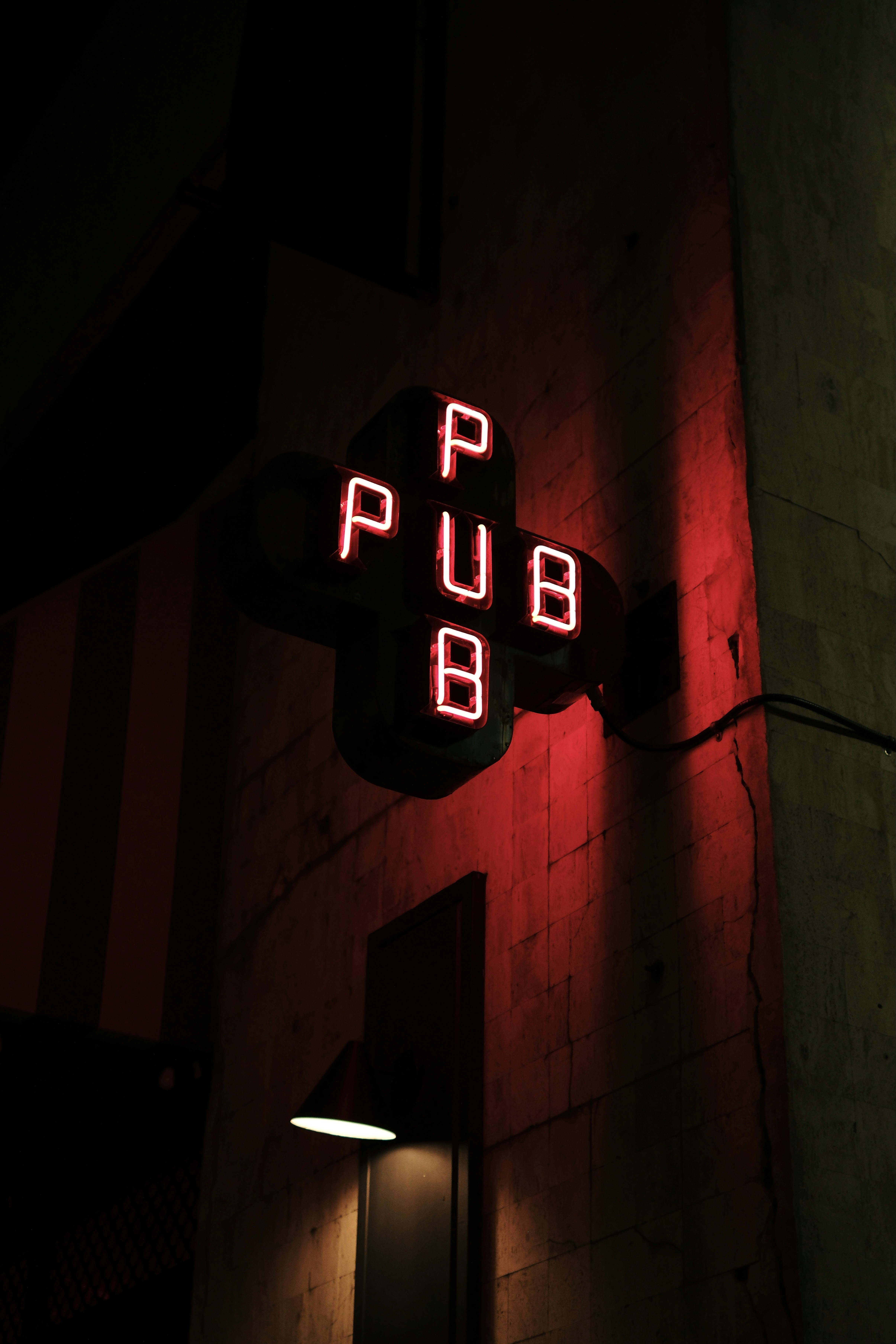 Instagram - @kaprion | A neon "pub" sign glows brightly at night.