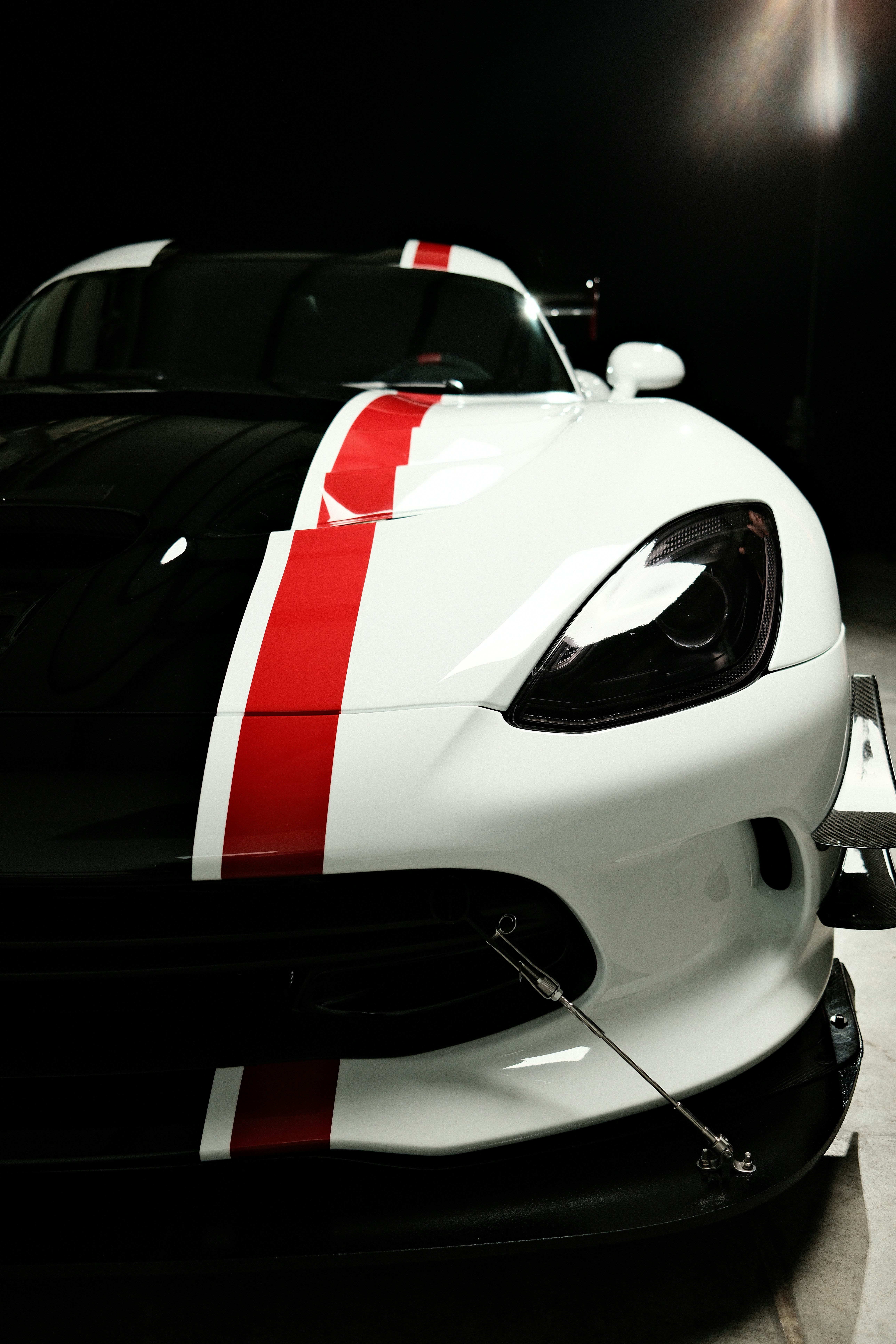Stripe-Driven Night Runner: Front-Quarter Portrait of a White Racer