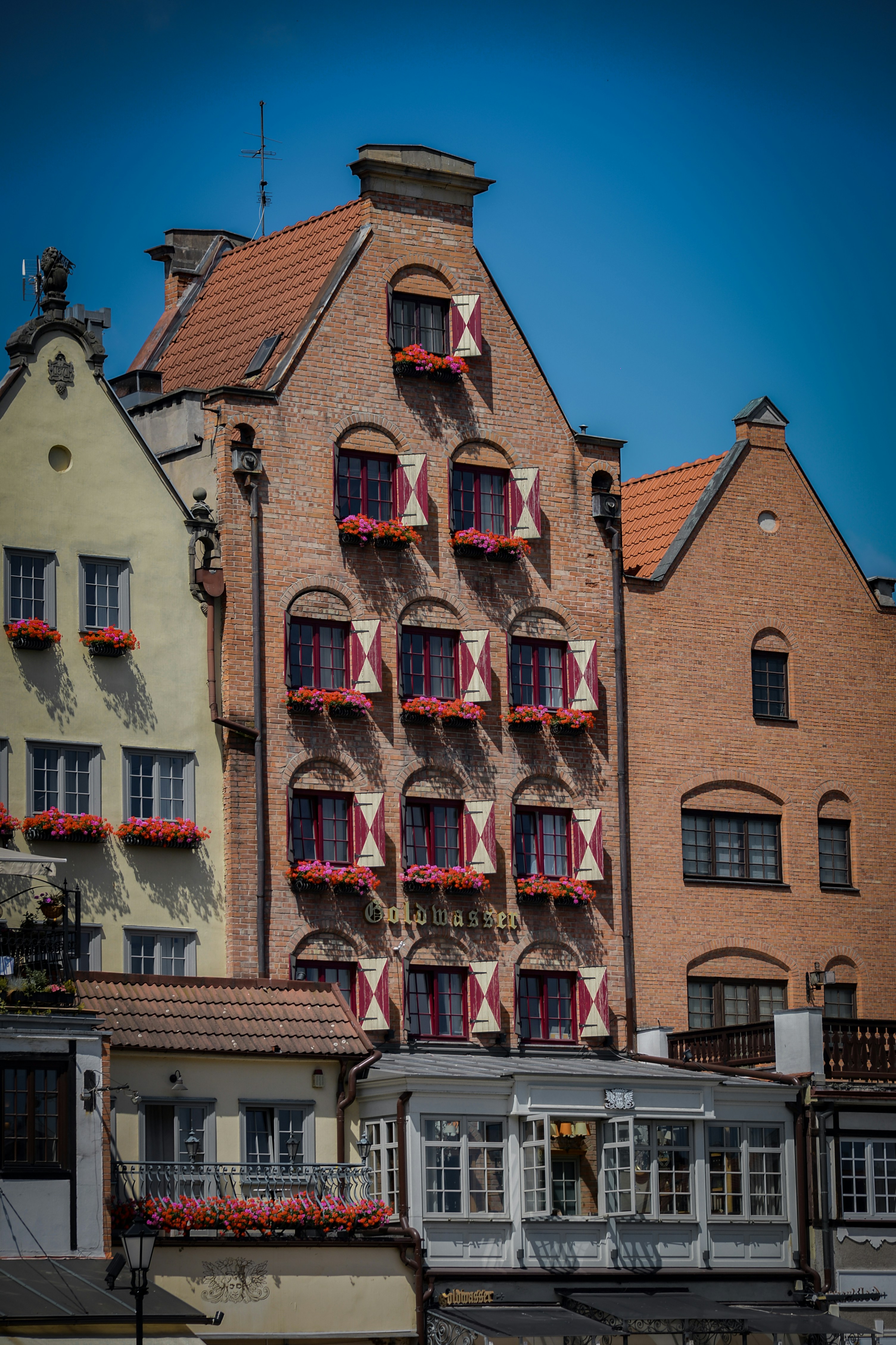 Colorful buildings stand tall under a bright blue sky.