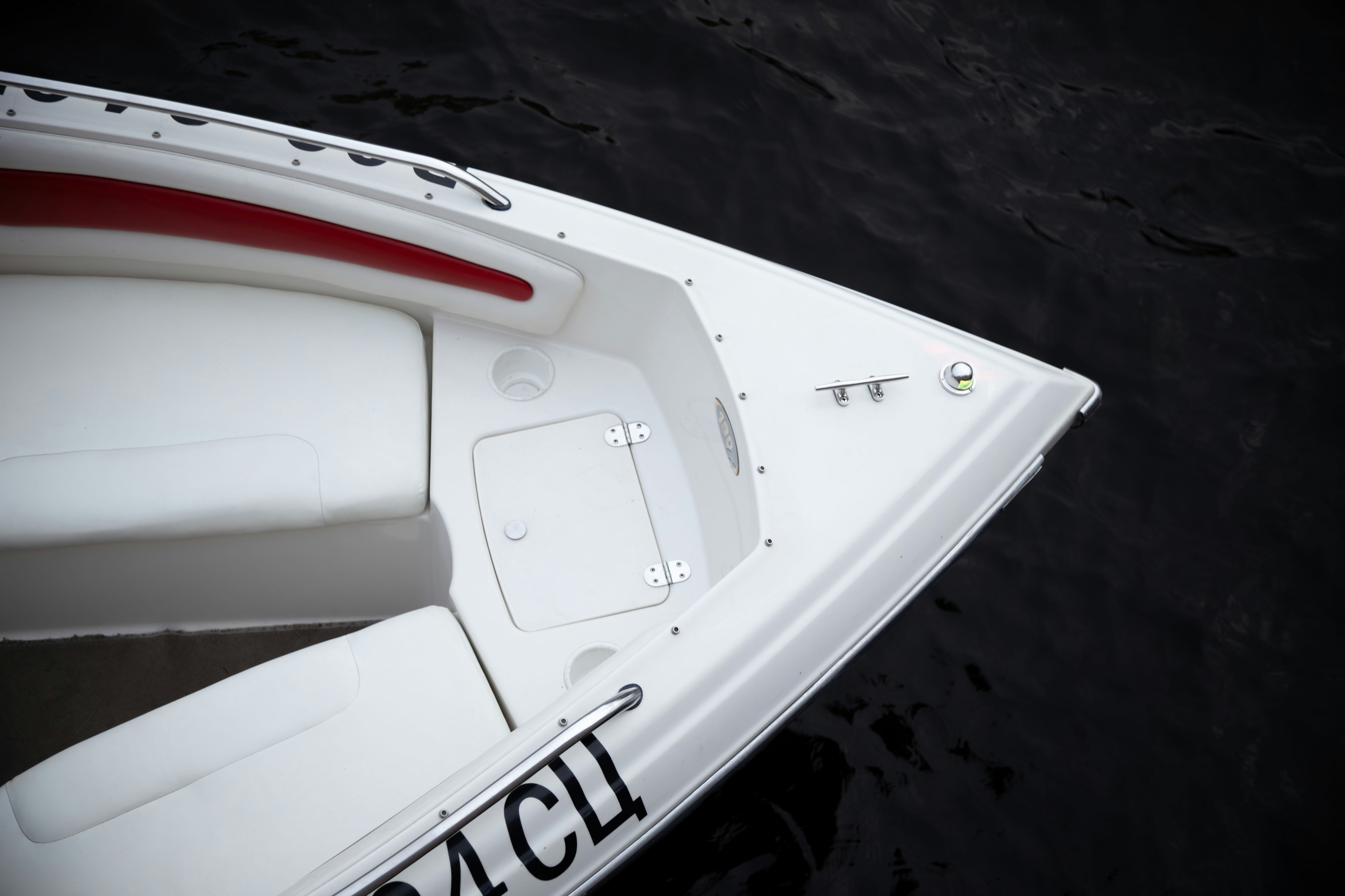 Overhead Glint: White Speedboat Cockpit Cutting Through Midnight Water