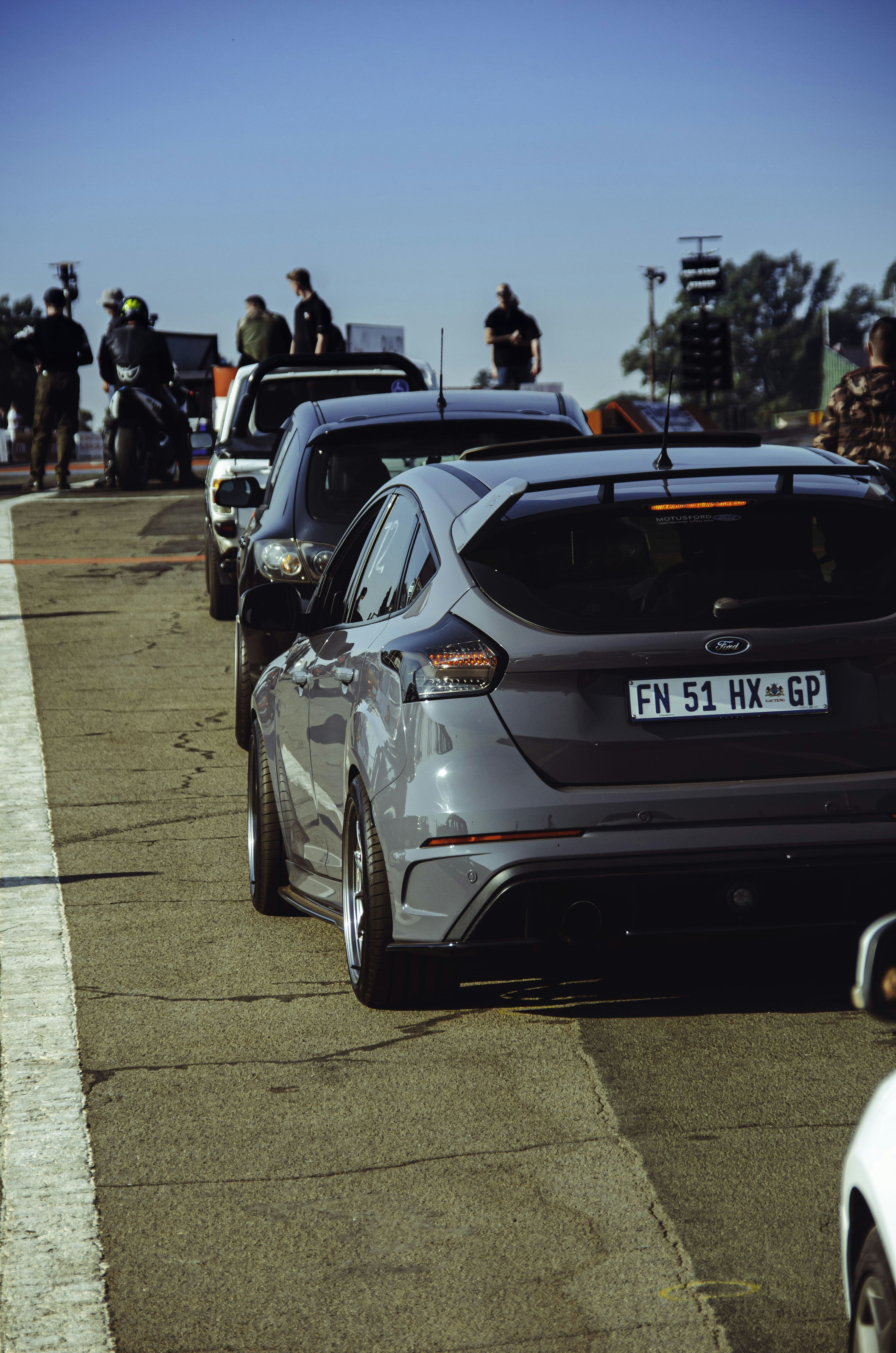Cars line up at a race track ready to compete. photo – Free Wallpaper ...
