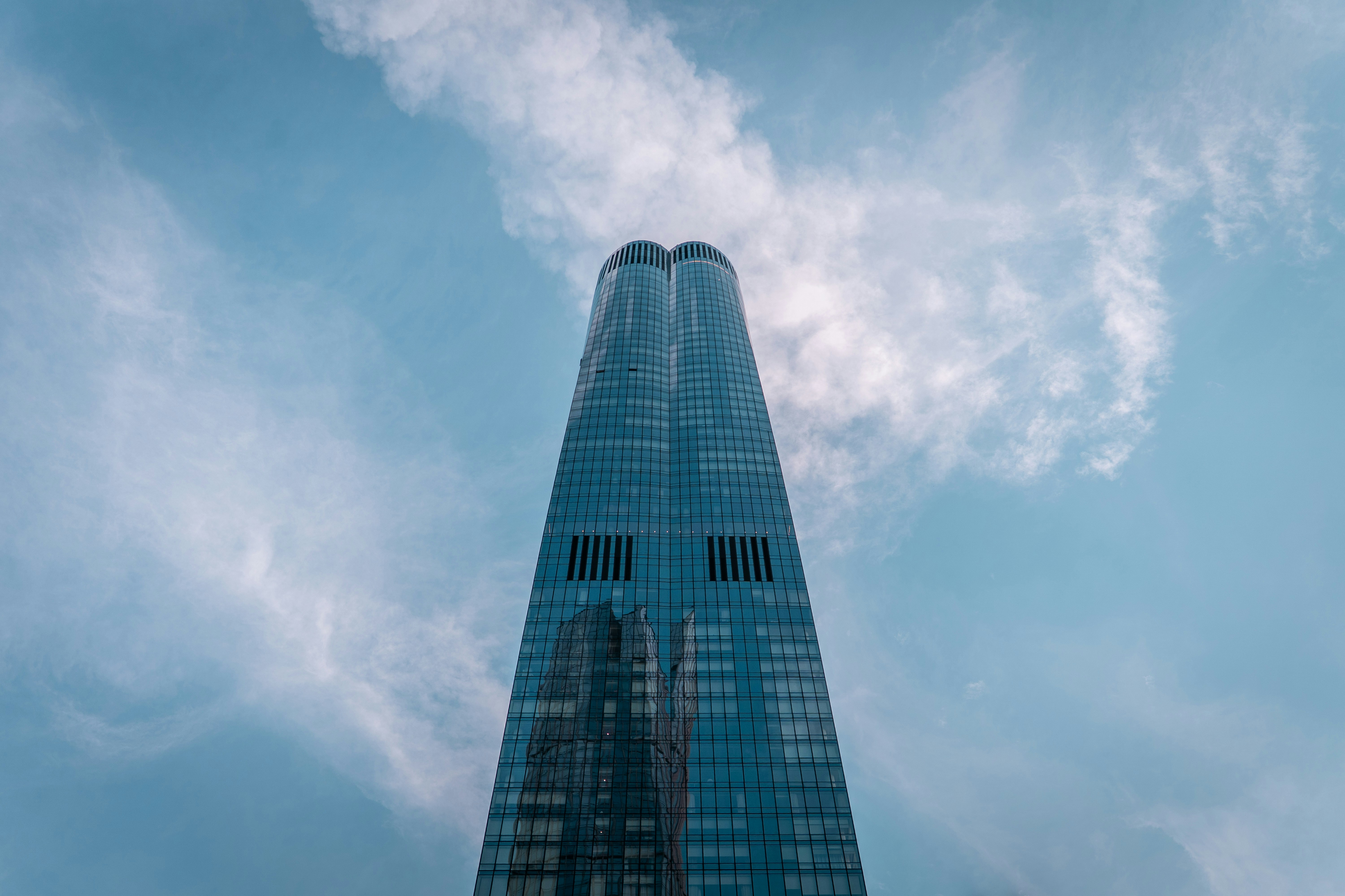 Tall skyscraper reaching into the blue sky.