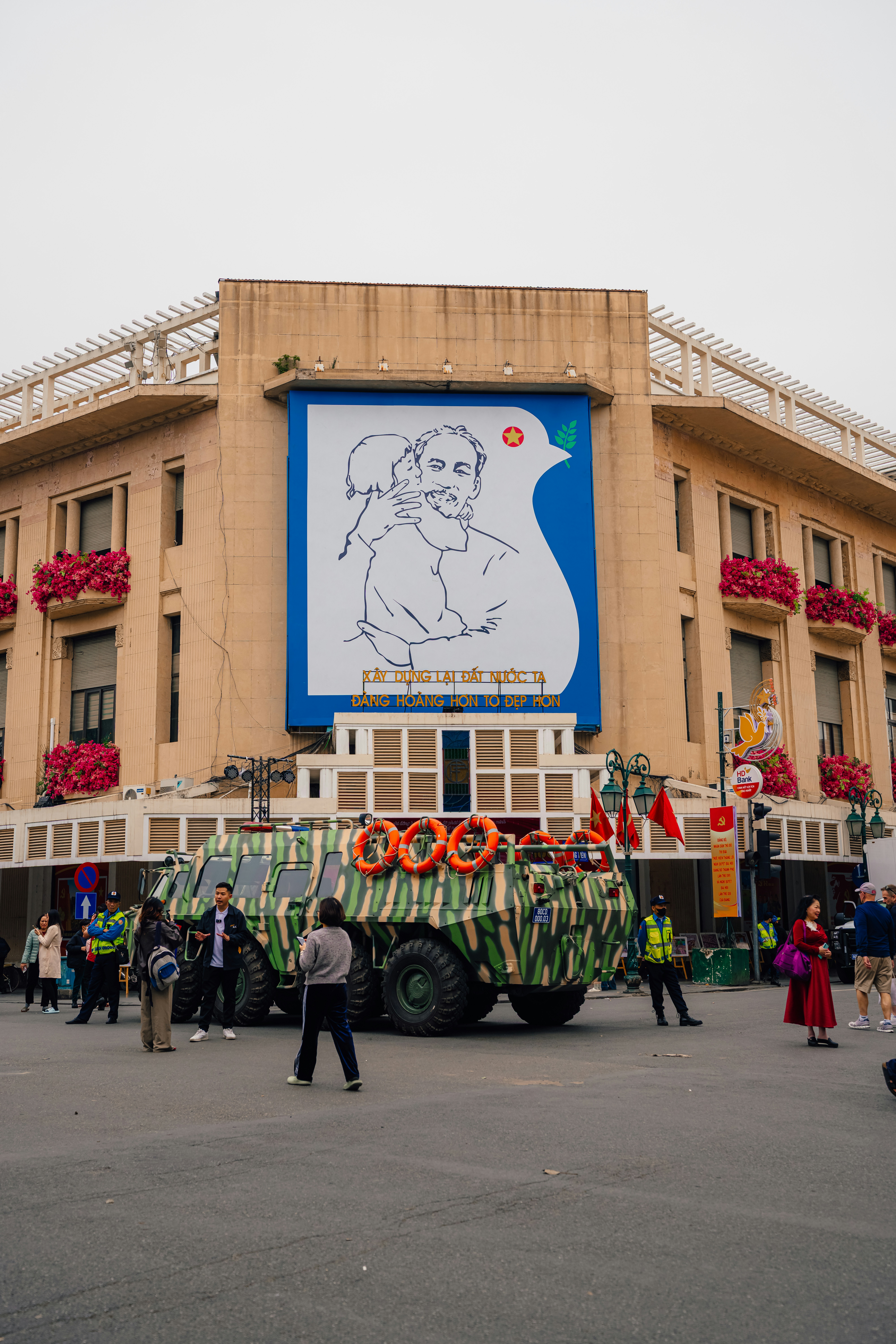 Public Square Spectacle: Tank Parade in Front of a Bannered Civic Building