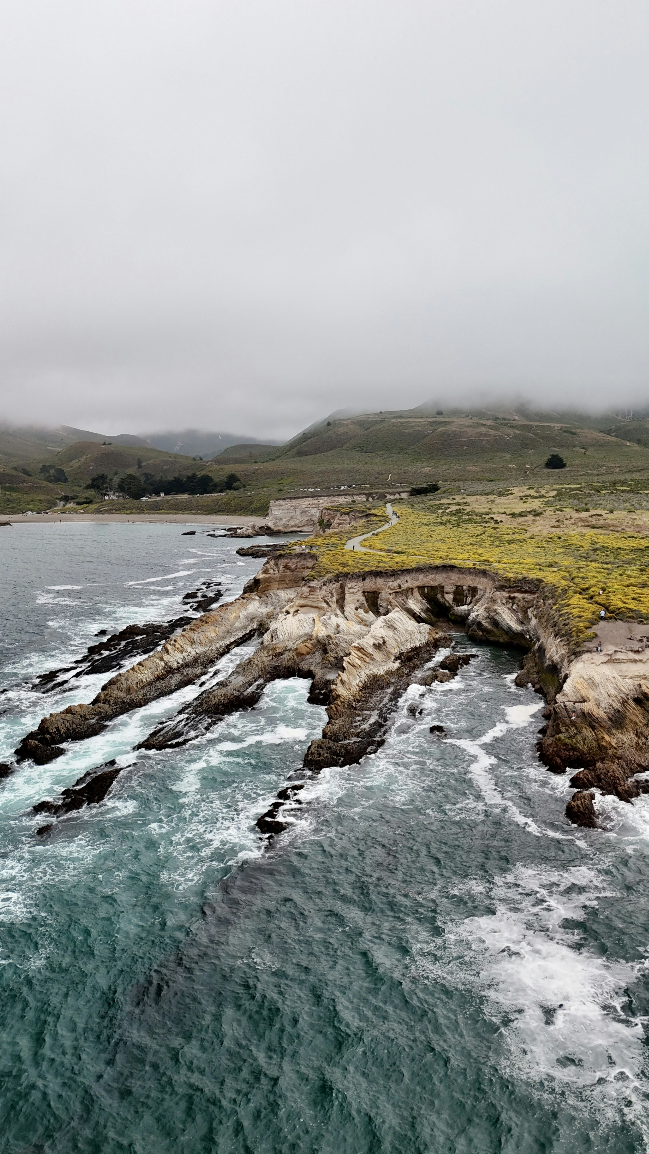 Cliffs and Foam along a Rugged Coastal Ridge