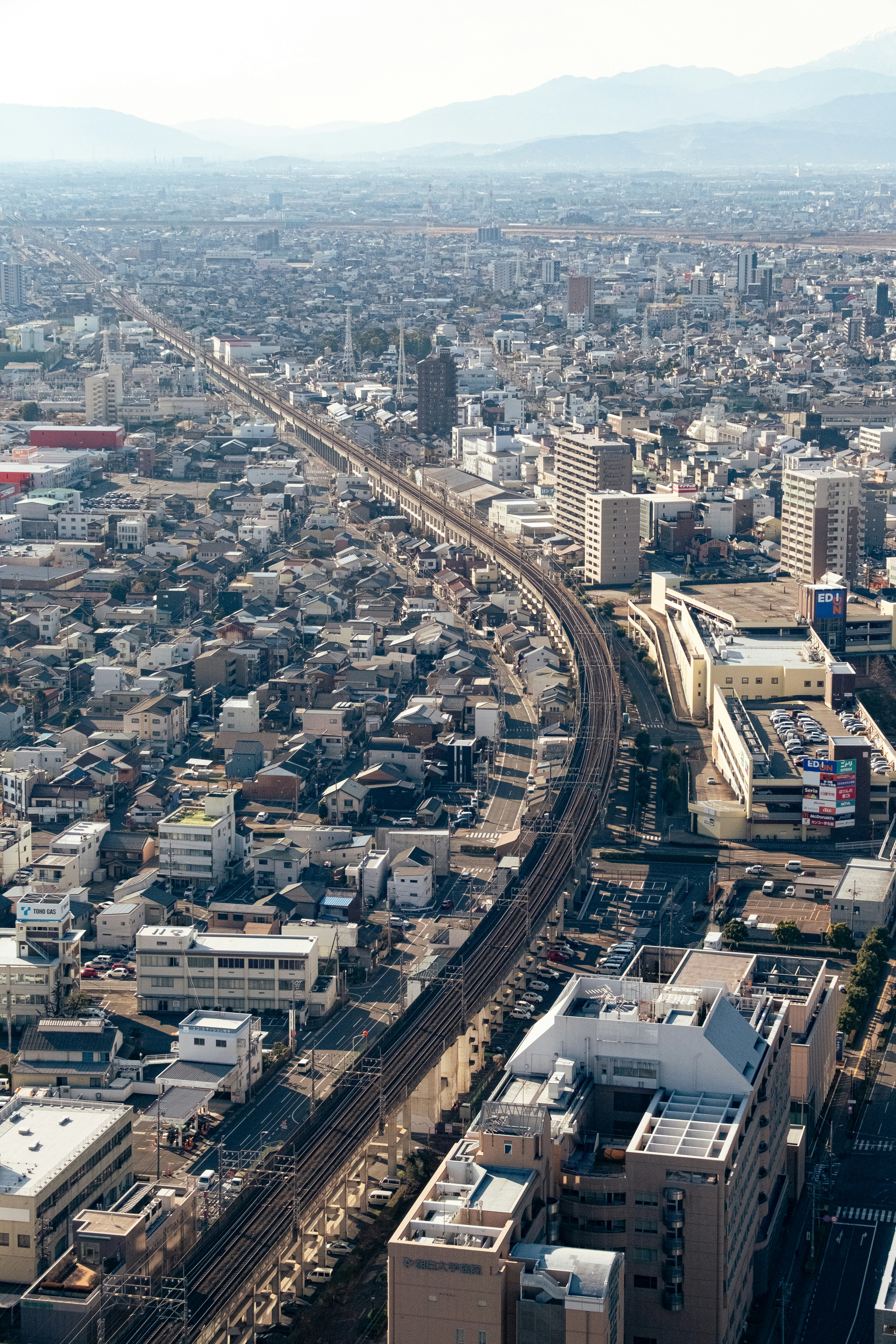 An aerial view of a city with train tracks.