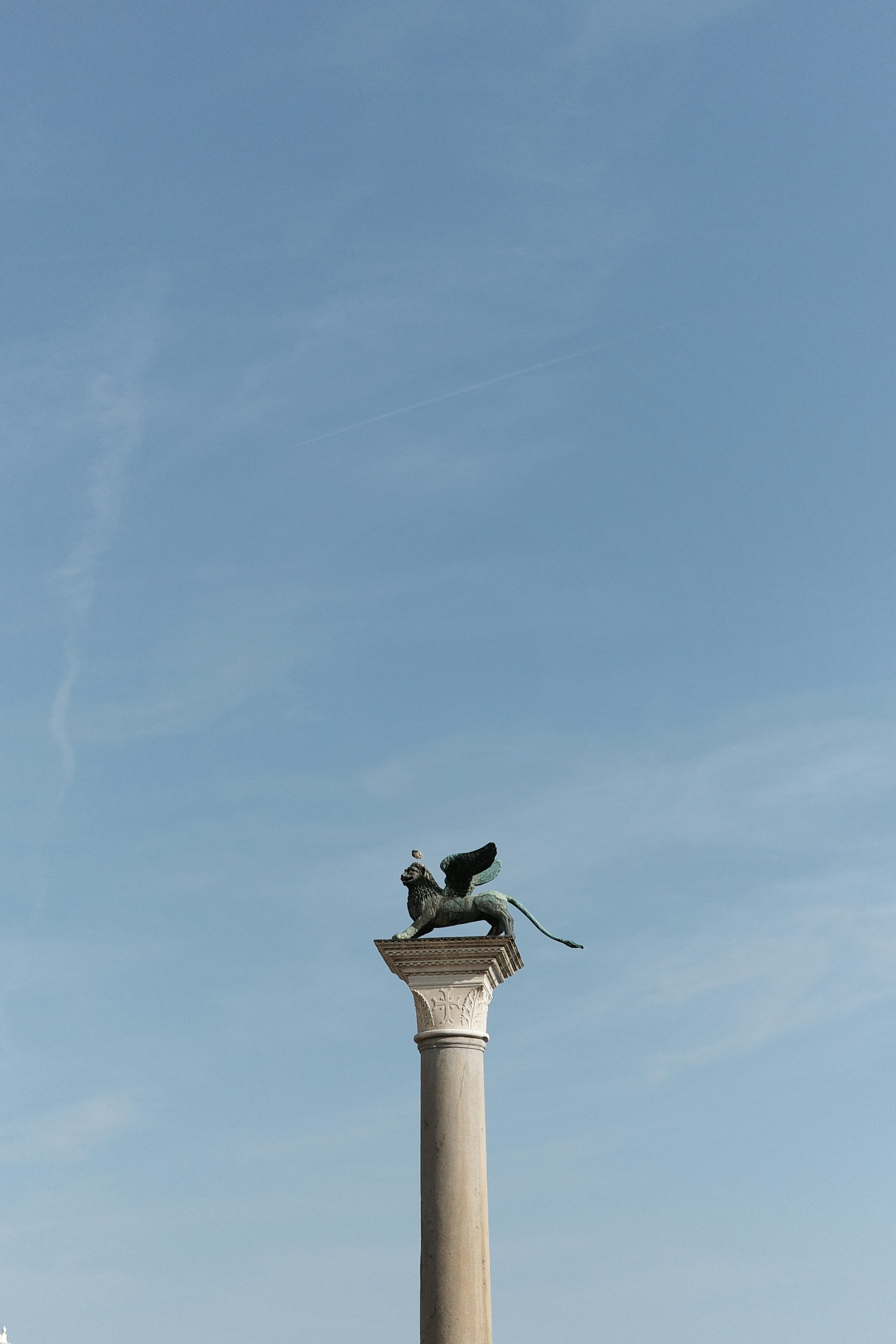 A winged lion statue rests atop a column.
