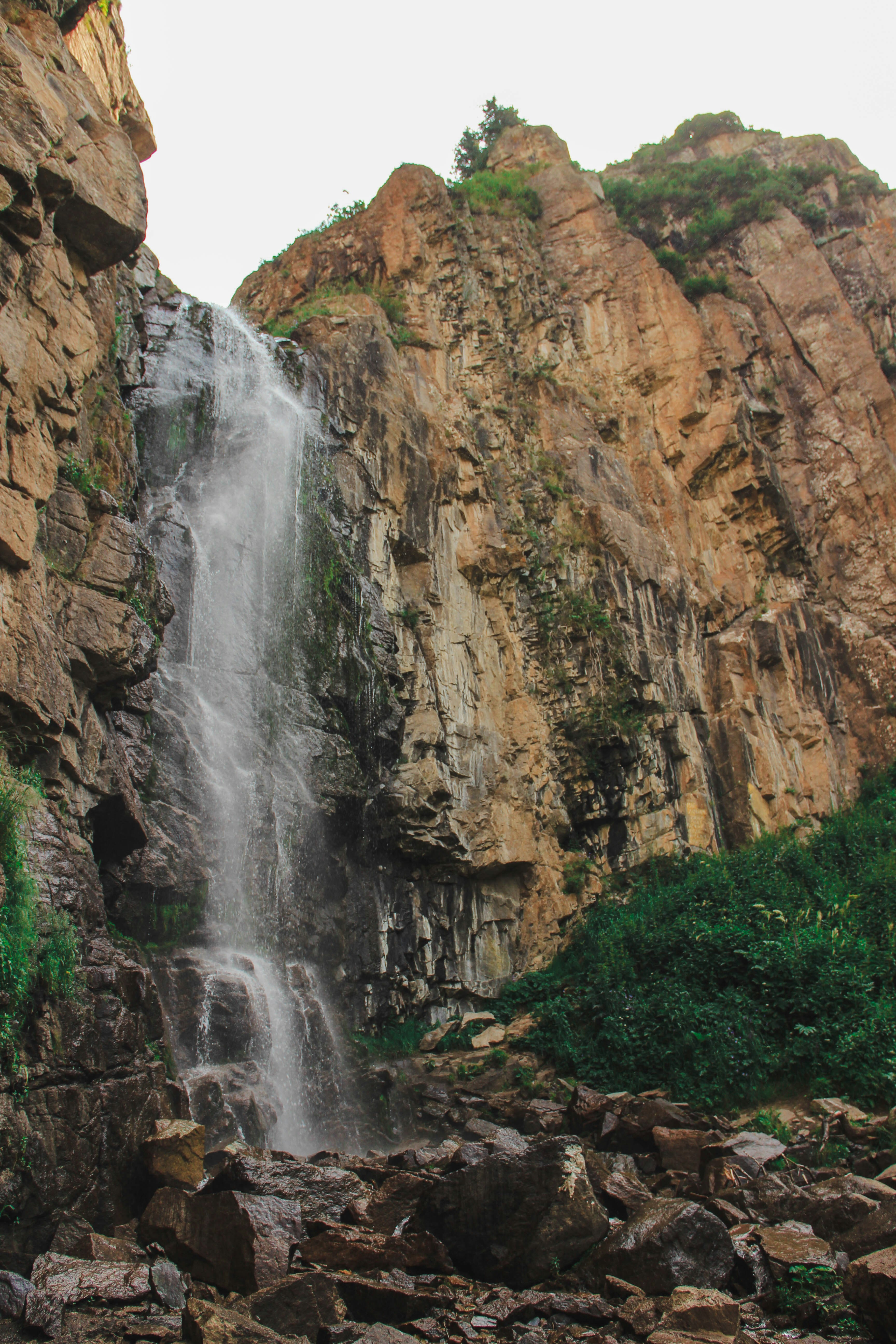 A waterfall cascades down a rocky cliff.