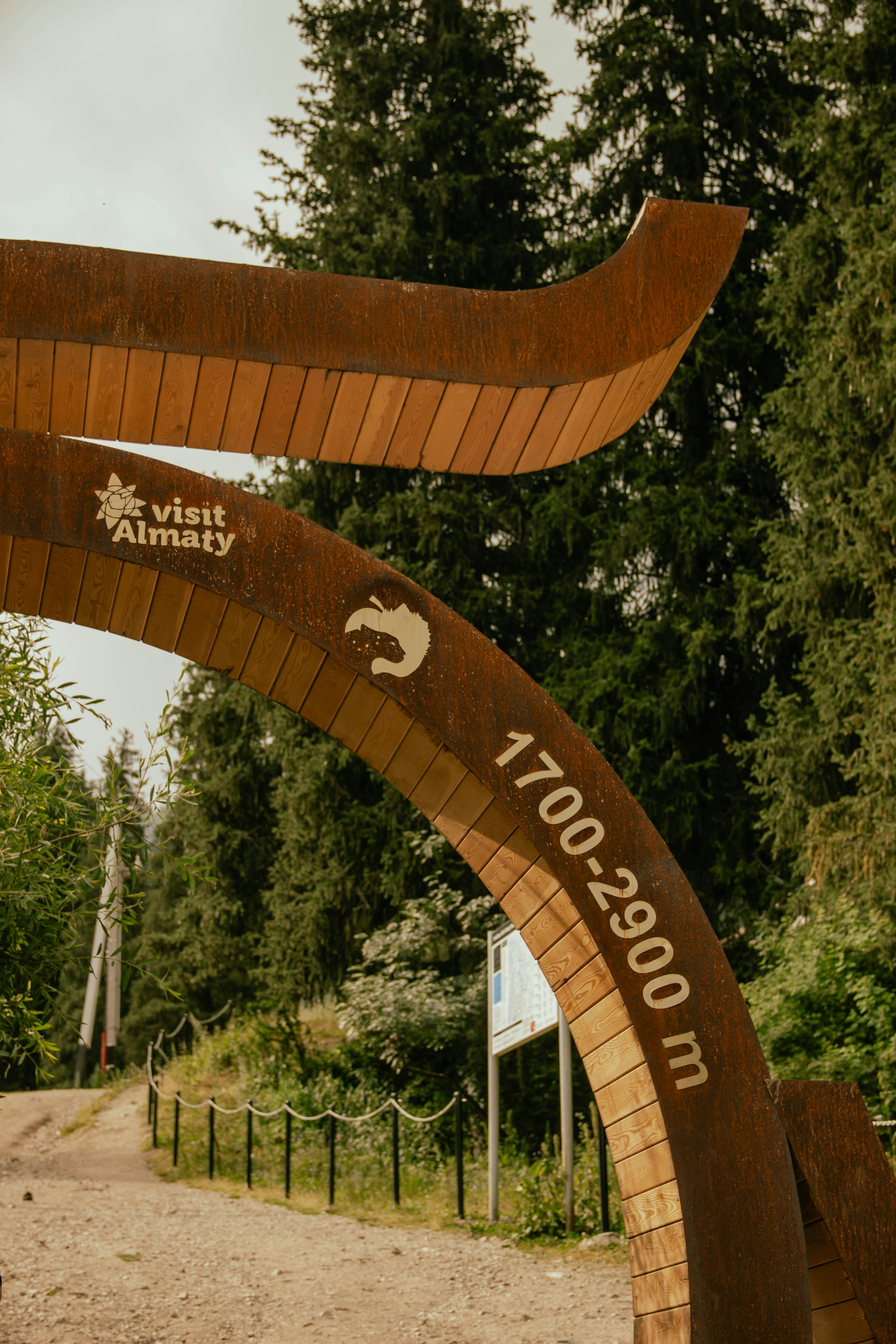 Weathered Rust Arch Marking 1700-2900 m Amid Pine Forest