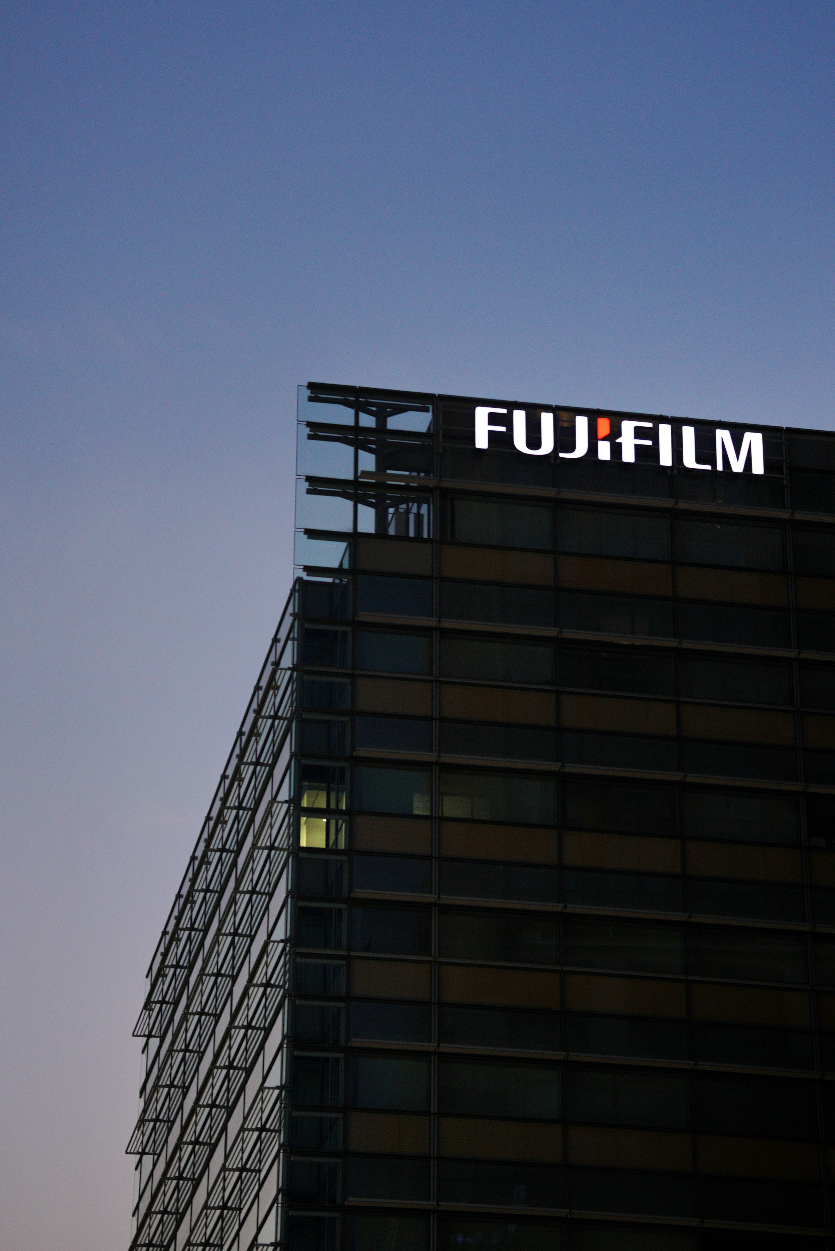 Fujifilm's illuminated logo atop a tall building. photo – Free City ...