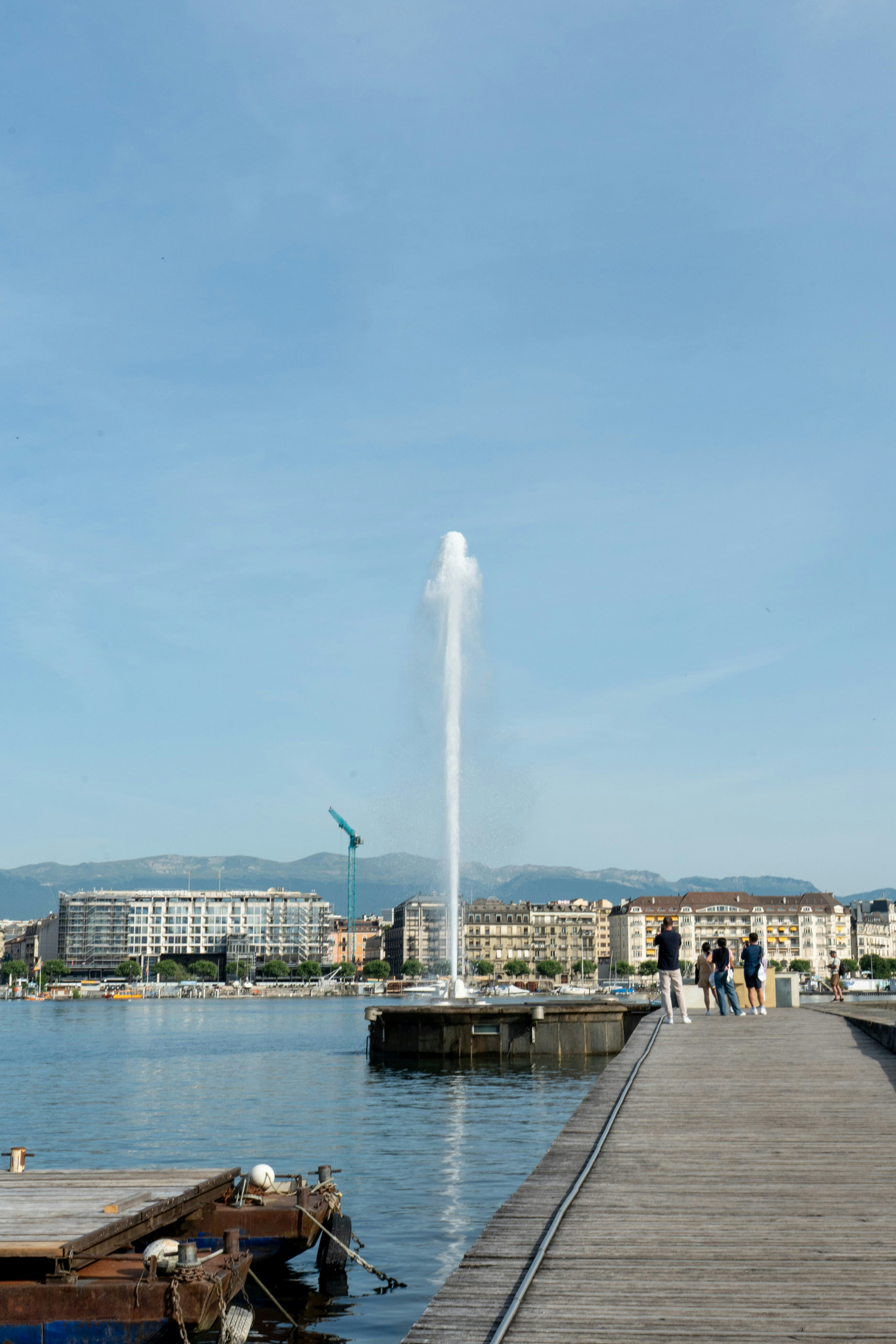 A tall fountain shoots water over lake geneva.
