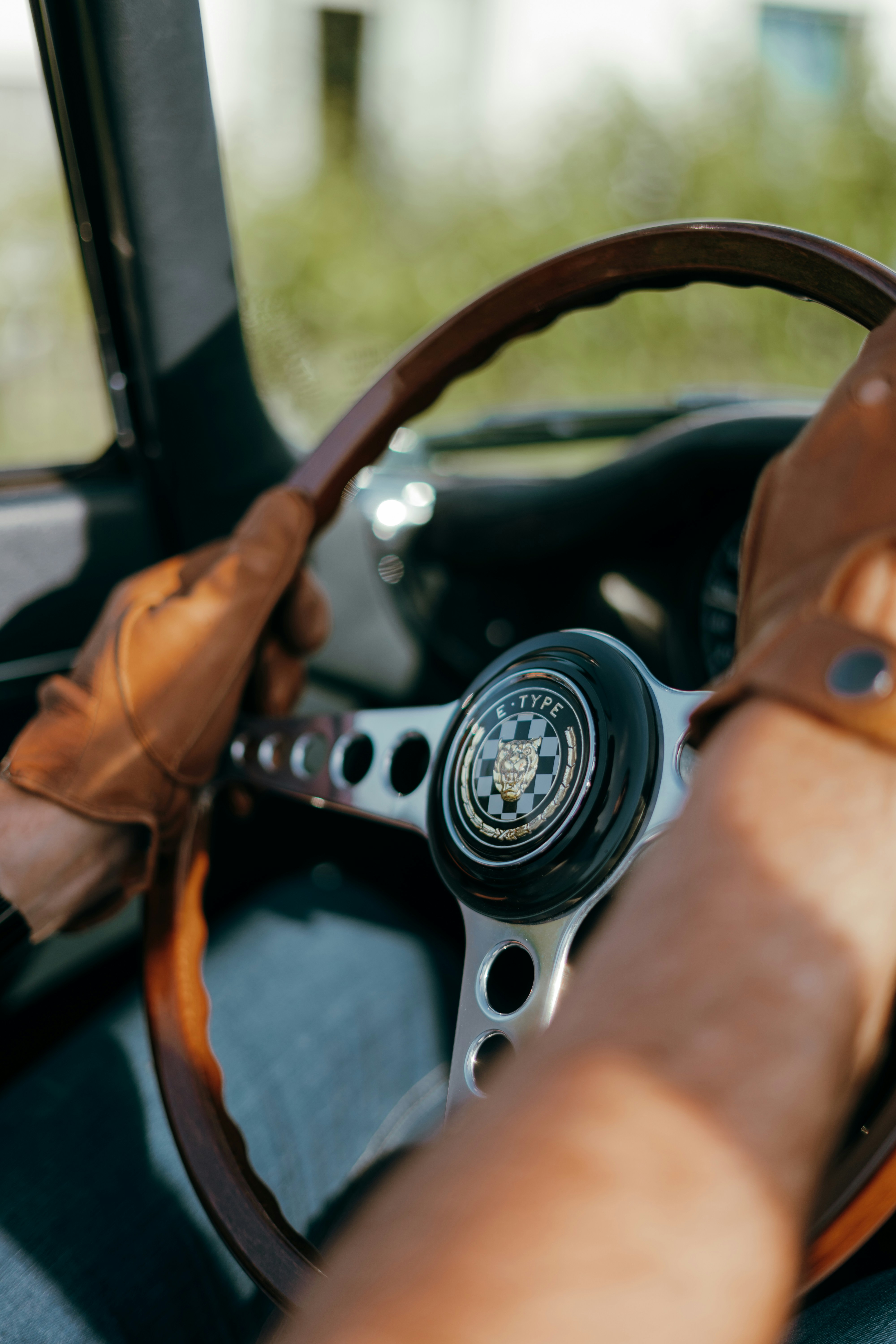 Leather and Steel: A Gloved Moment at the Vintage Steering Wheel