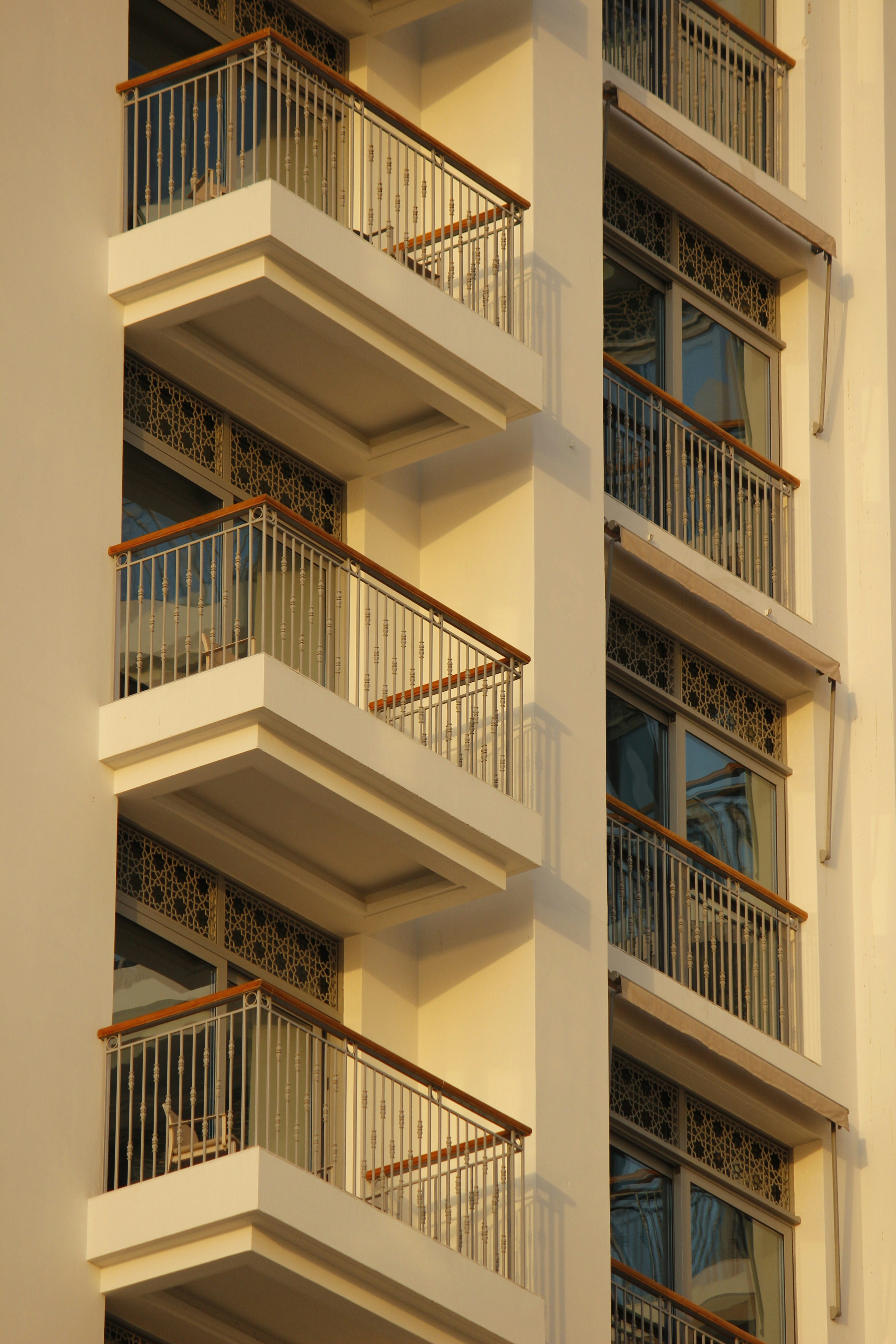 This photo was shot using an old Canon 🤍. | Balconies adorn the side of a modern building.