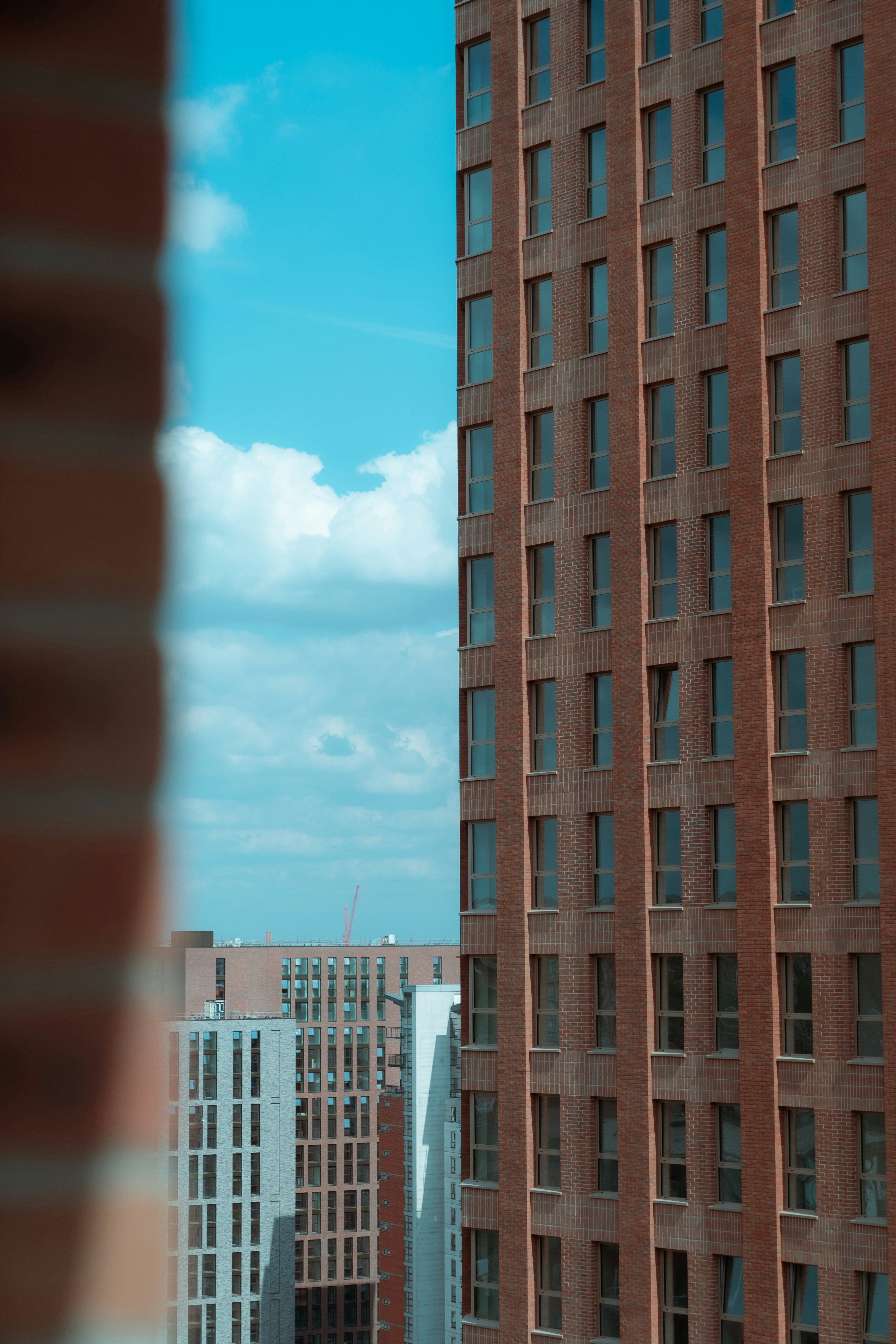 Tall buildings rise against a bright, blue sky.