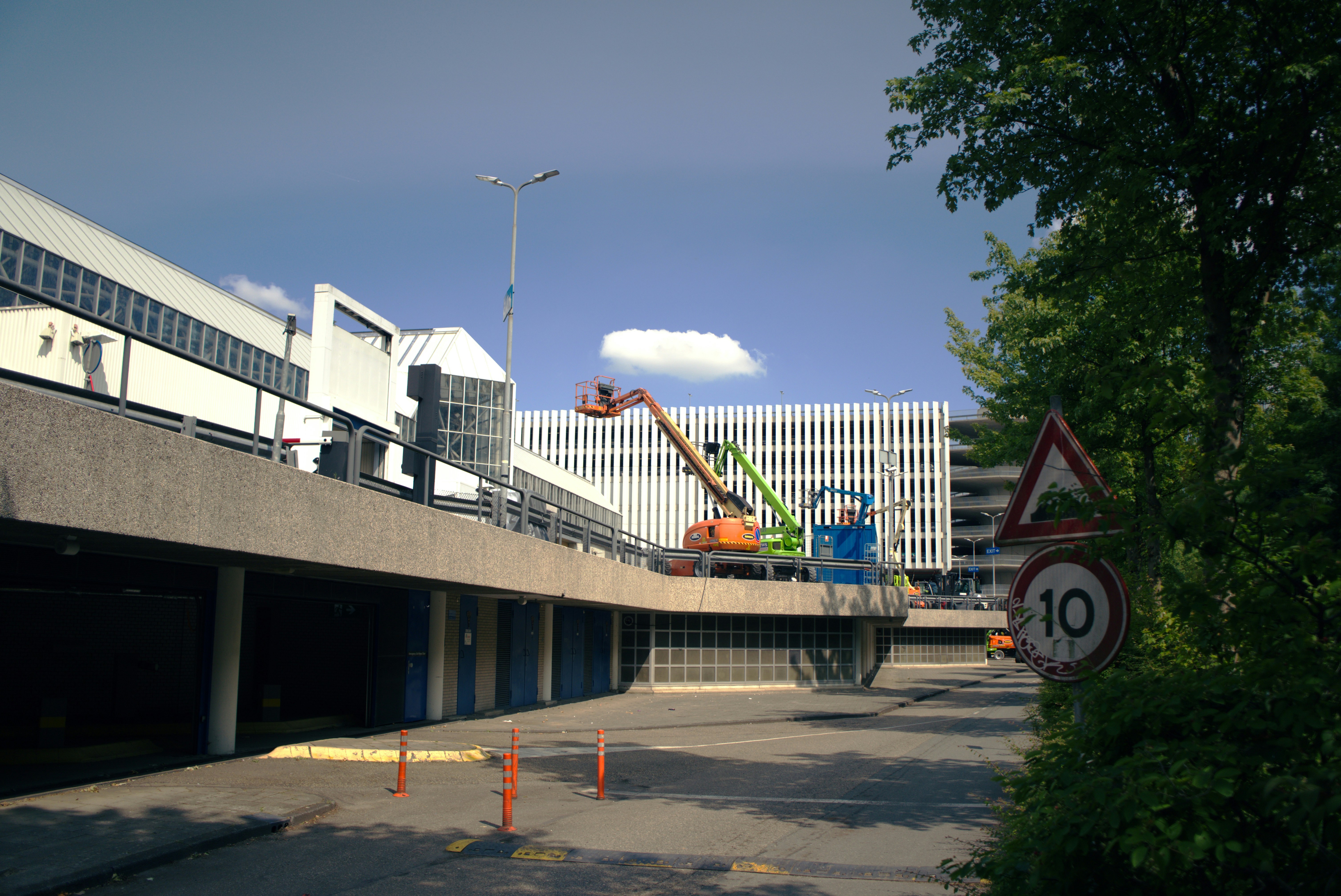 Construction equipment is working on a building.