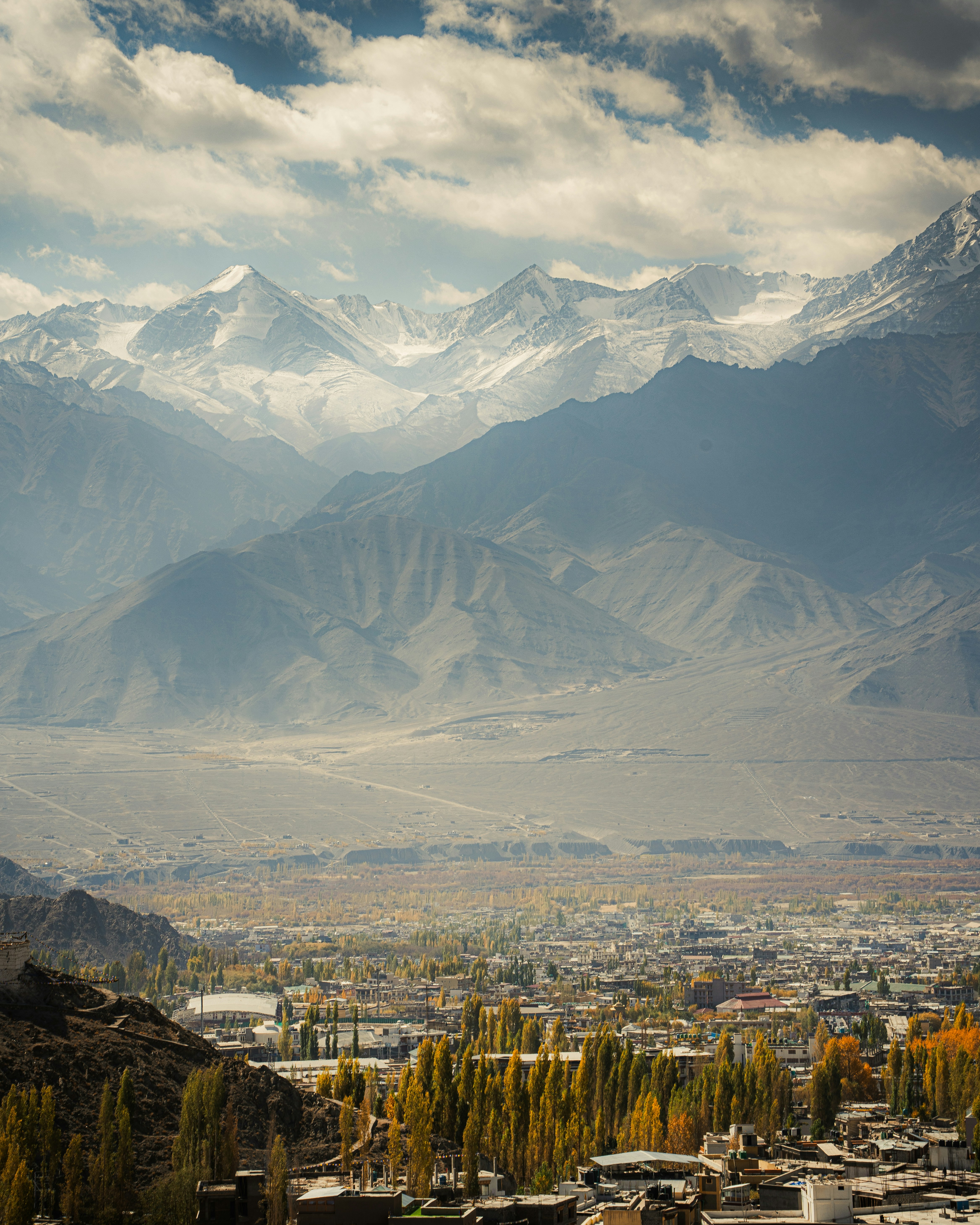 Majestic mountains loom over a city and valley.