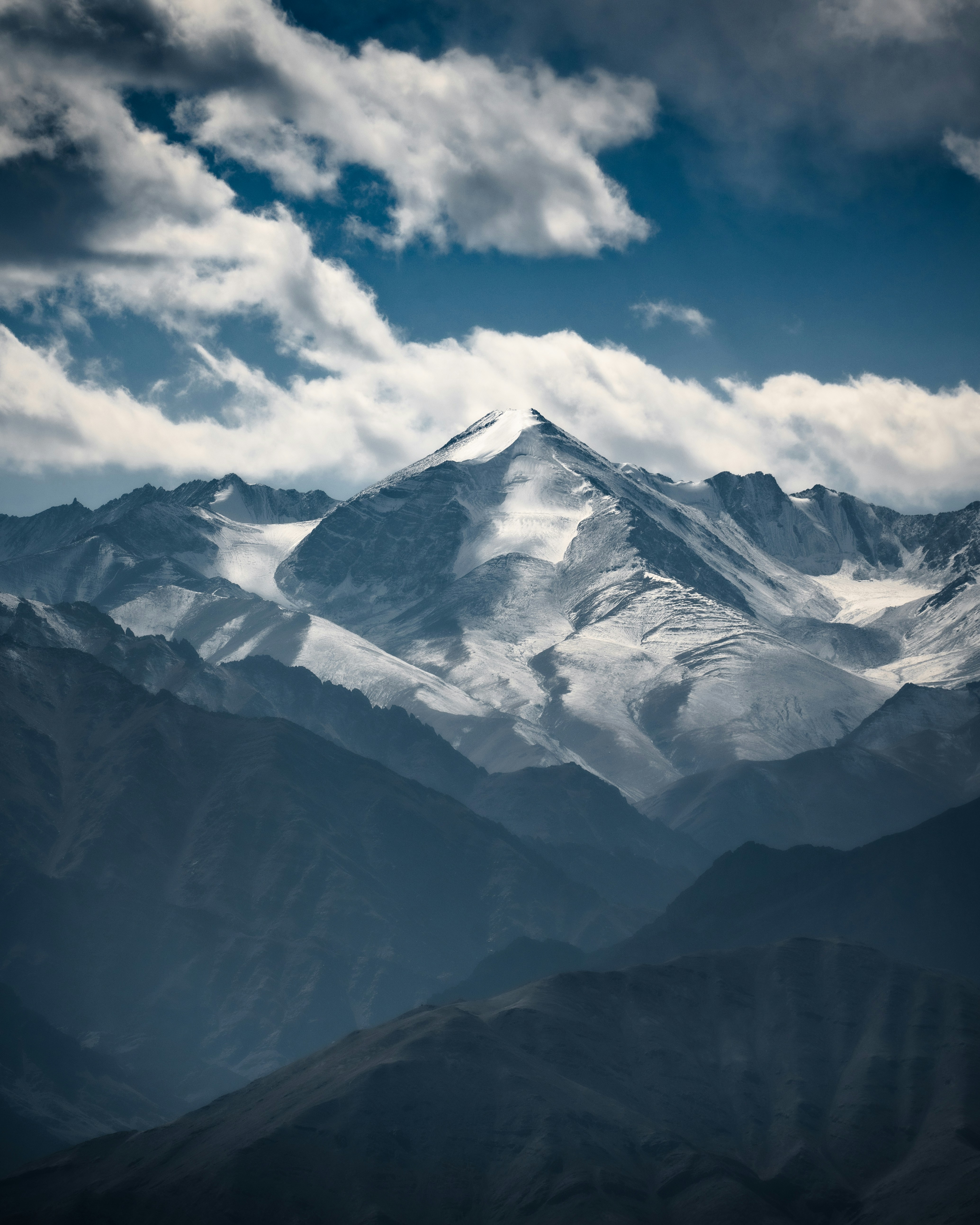 Snow-capped mountains rise under a partly cloudy sky.