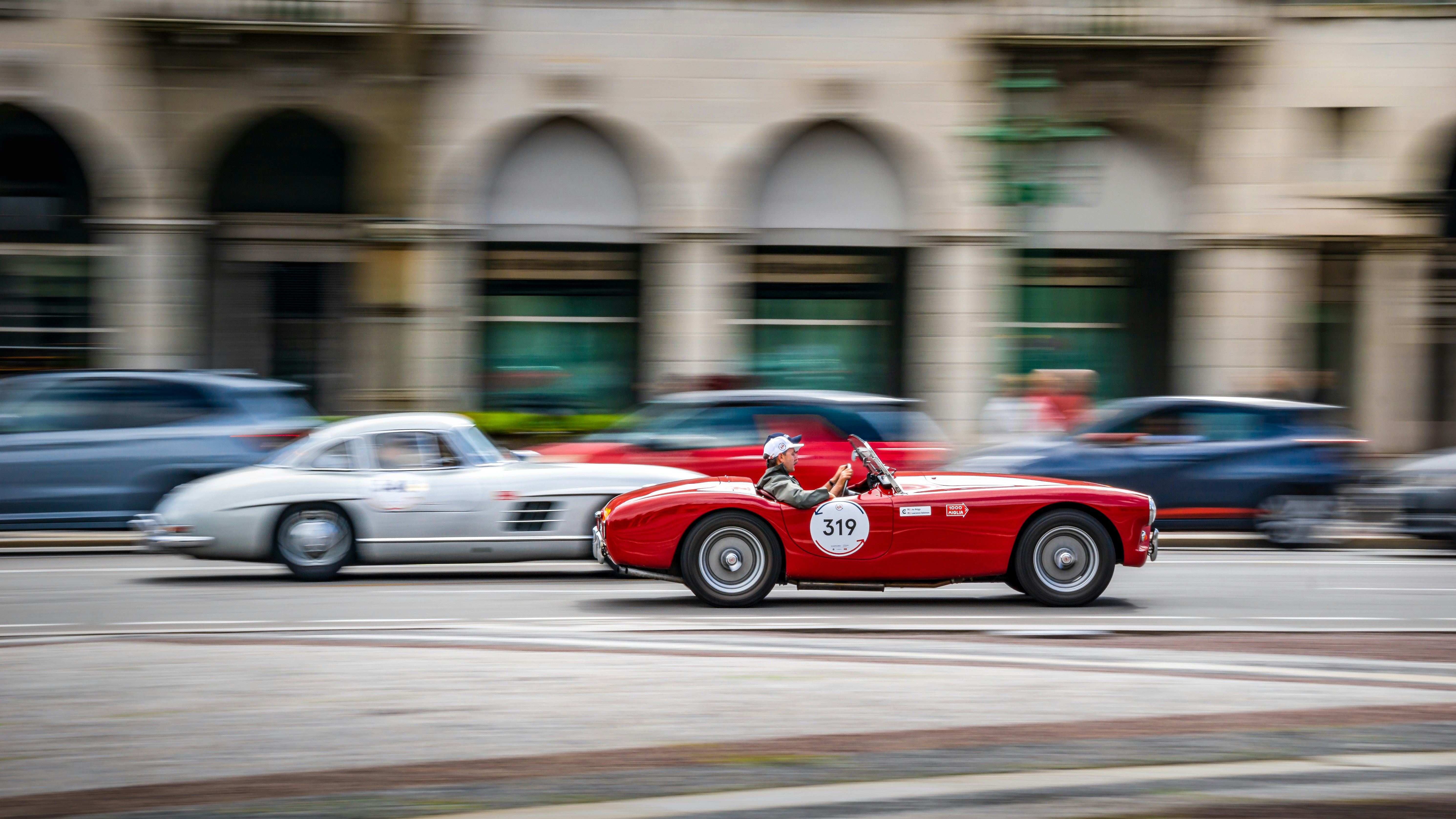 Red Classic: A Speeding Convertible Through Historic Streets