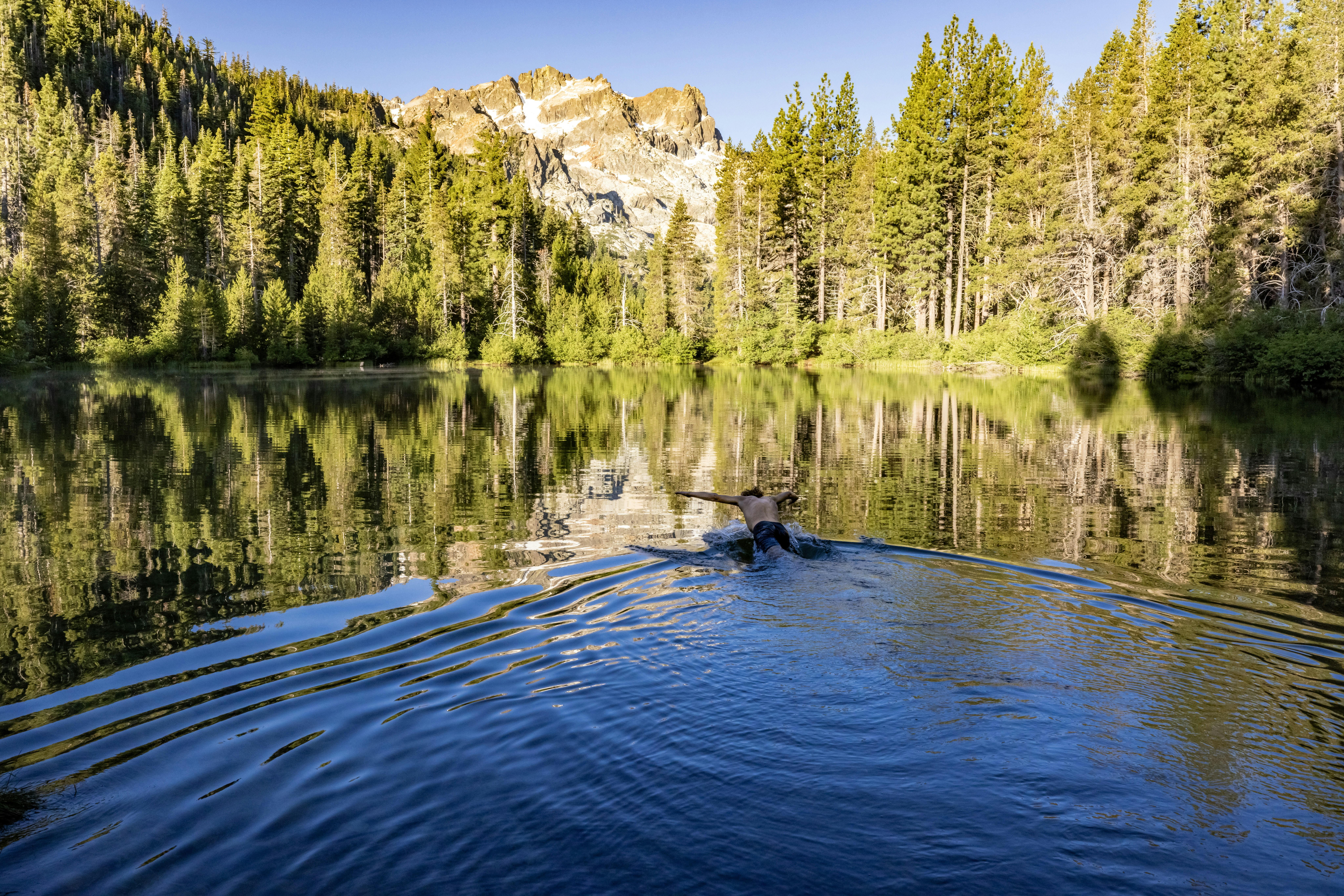 Sierra Buttes early morning swim by a brave soul willing to endure 50 degree mountain water at 6 a.m.