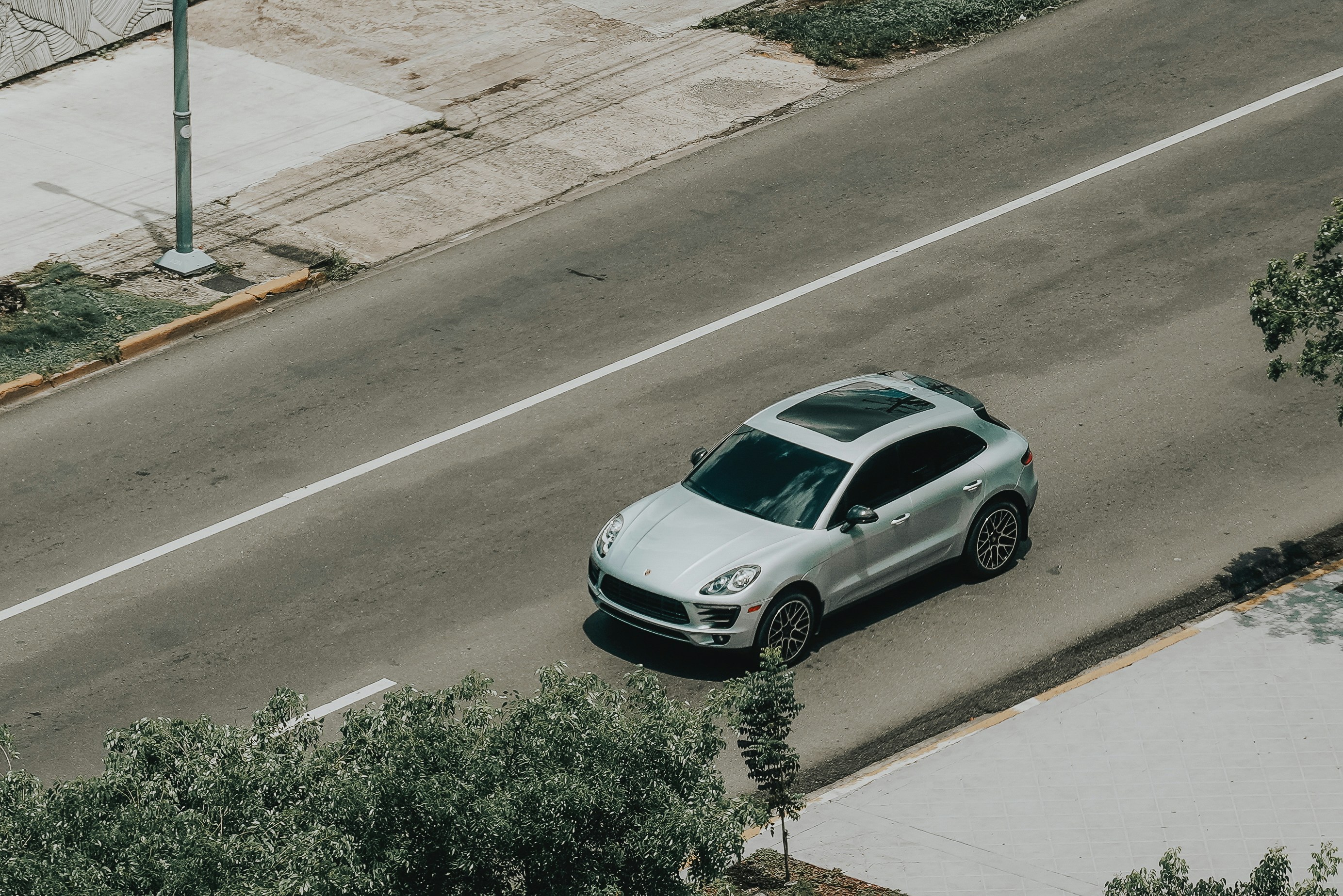 Midday Silver on a Quiet Boulevard: An Aerial Car Portrait