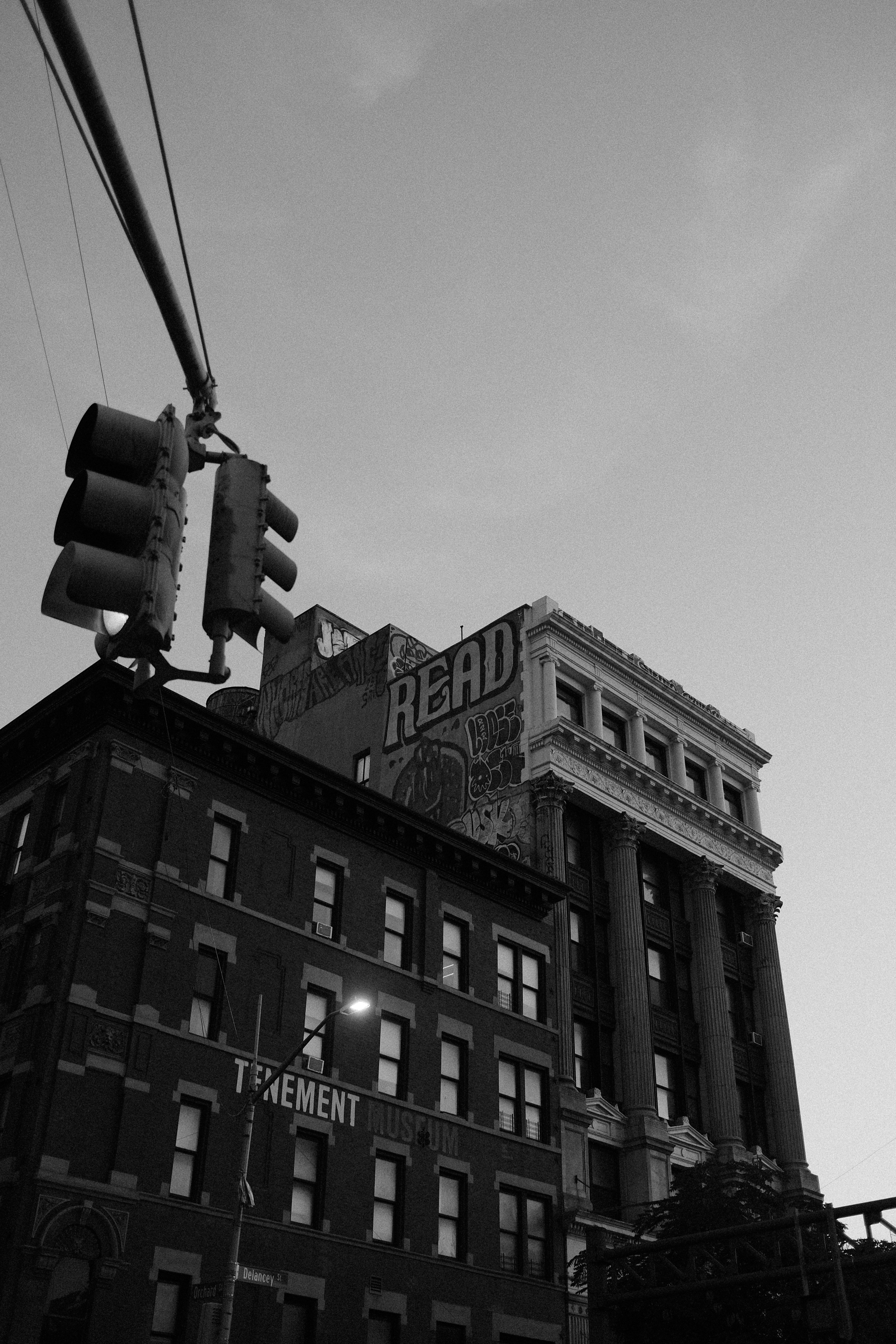 Historic buildings adorned with a bold 'READ' mural under a dusky sky, capturing the essence of urban storytelling.