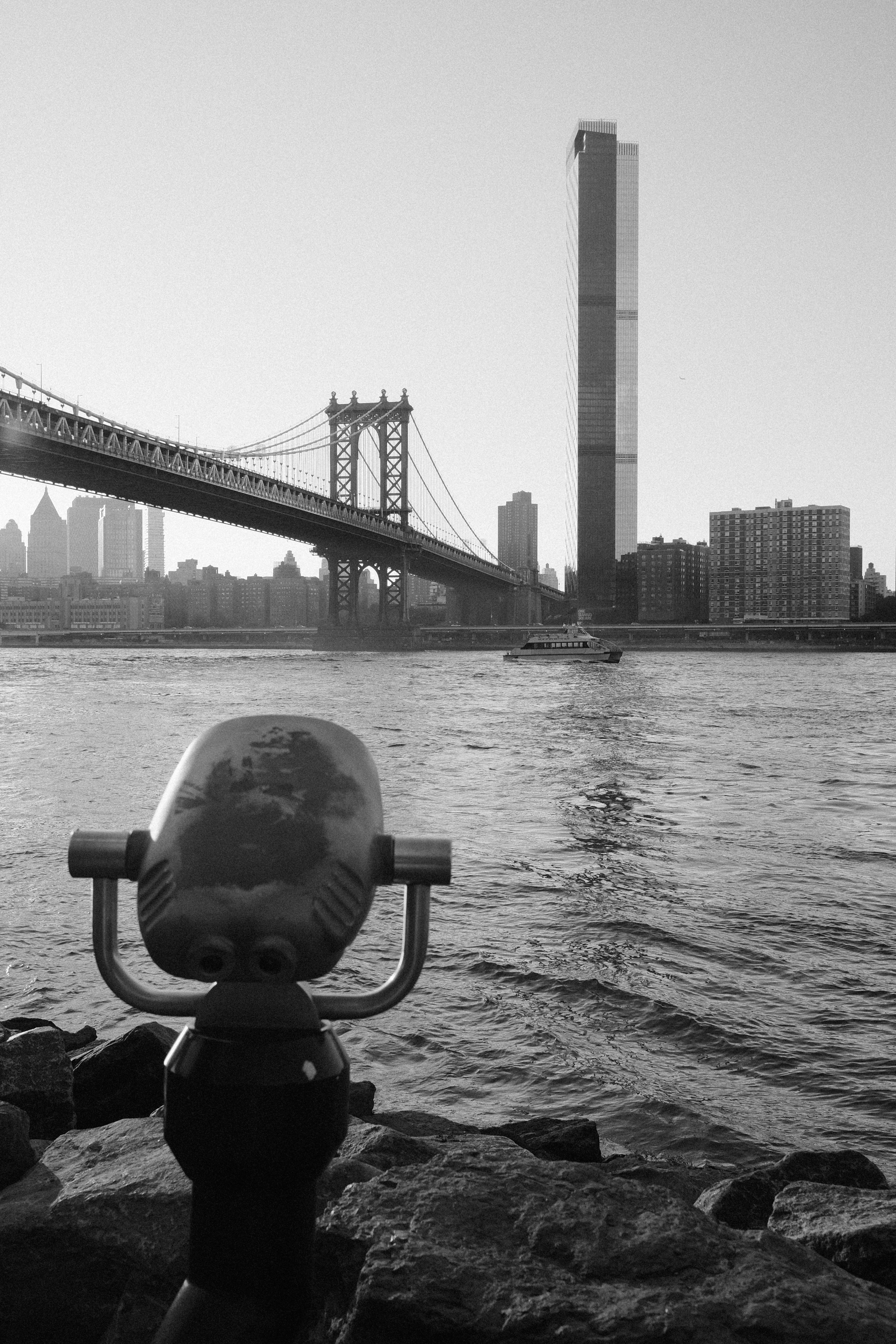 A bridge and skyscrapers are seen with a viewer.