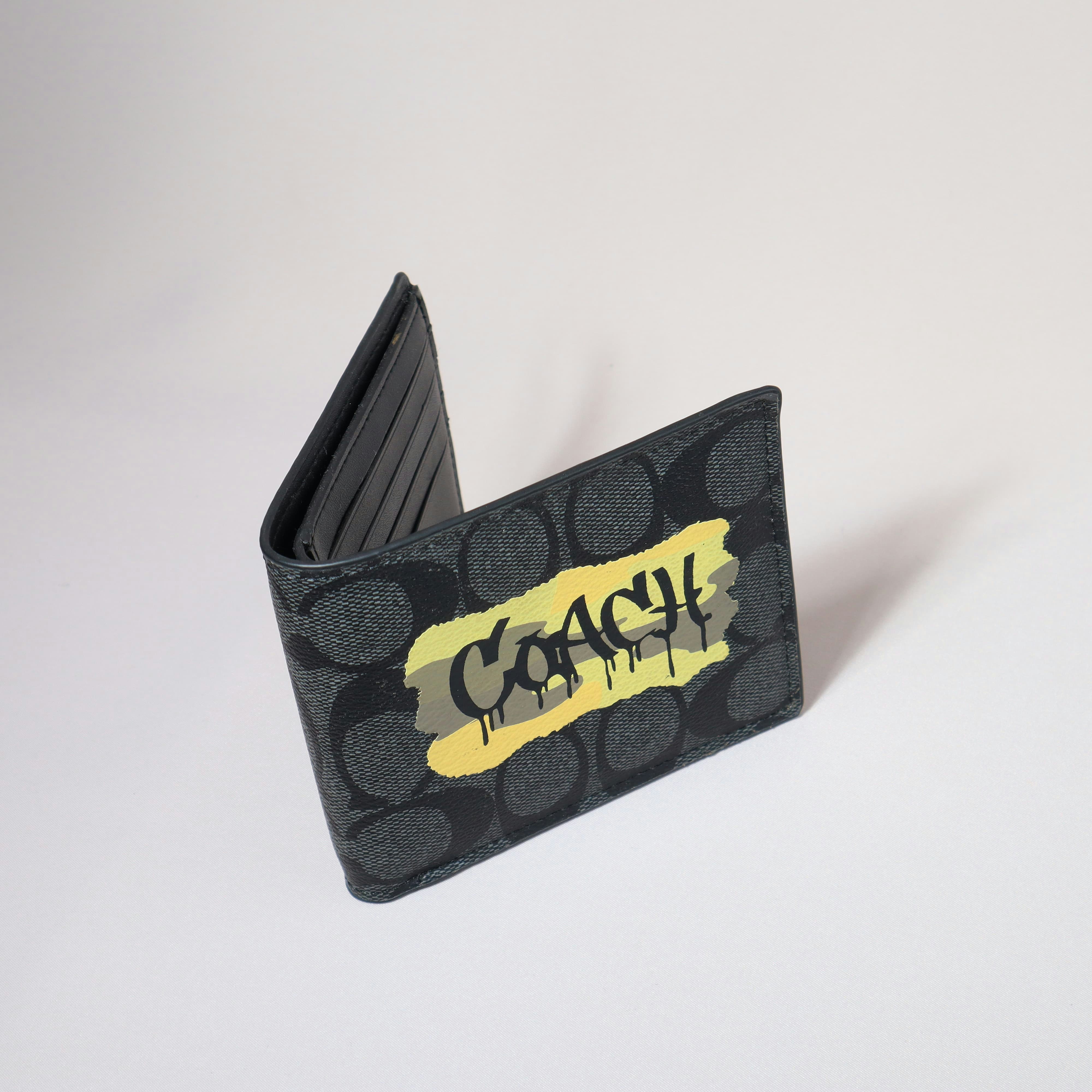 A black coach wallet with graffiti design. photo – Free Coach Image on ...